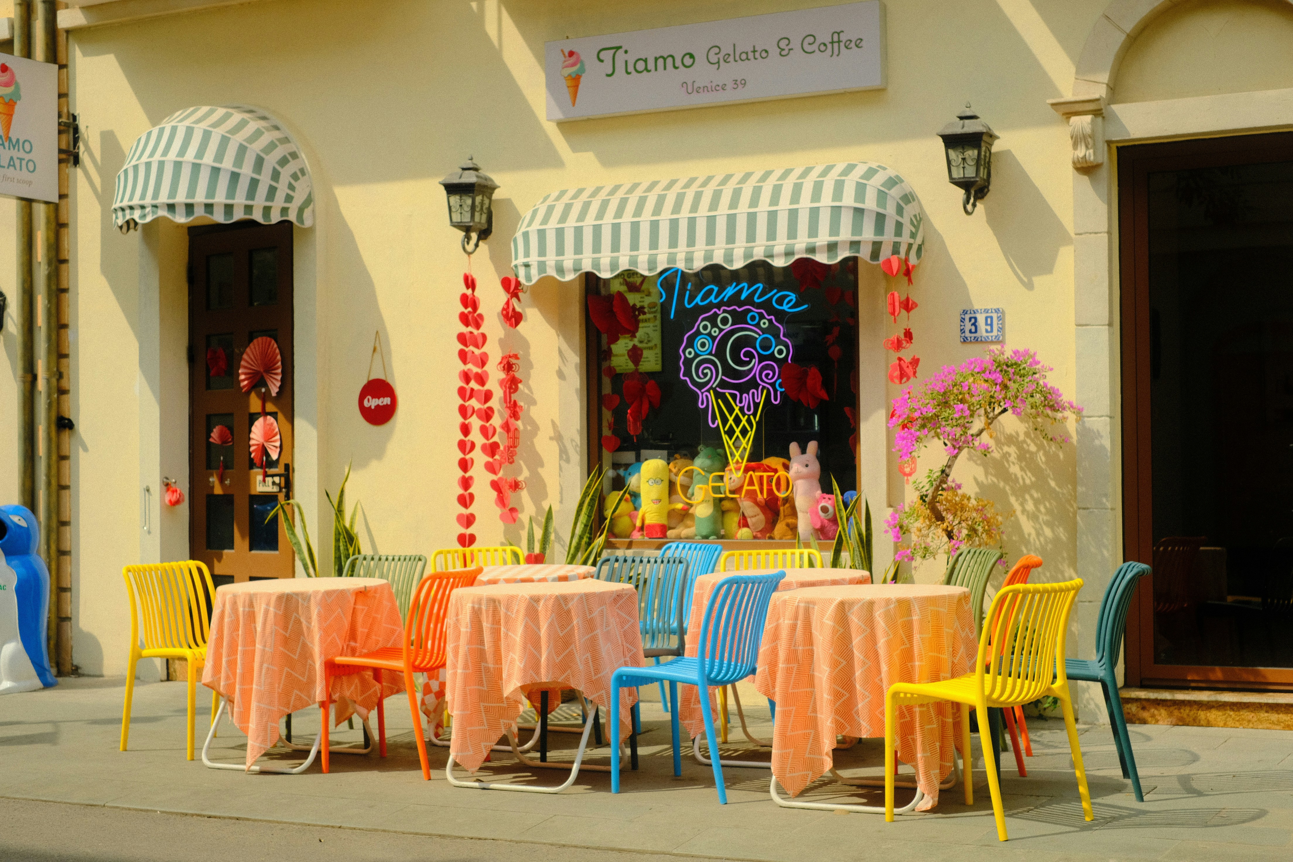 Colorful Café Terrace with Striped Awnings and Ice Cream Sign
