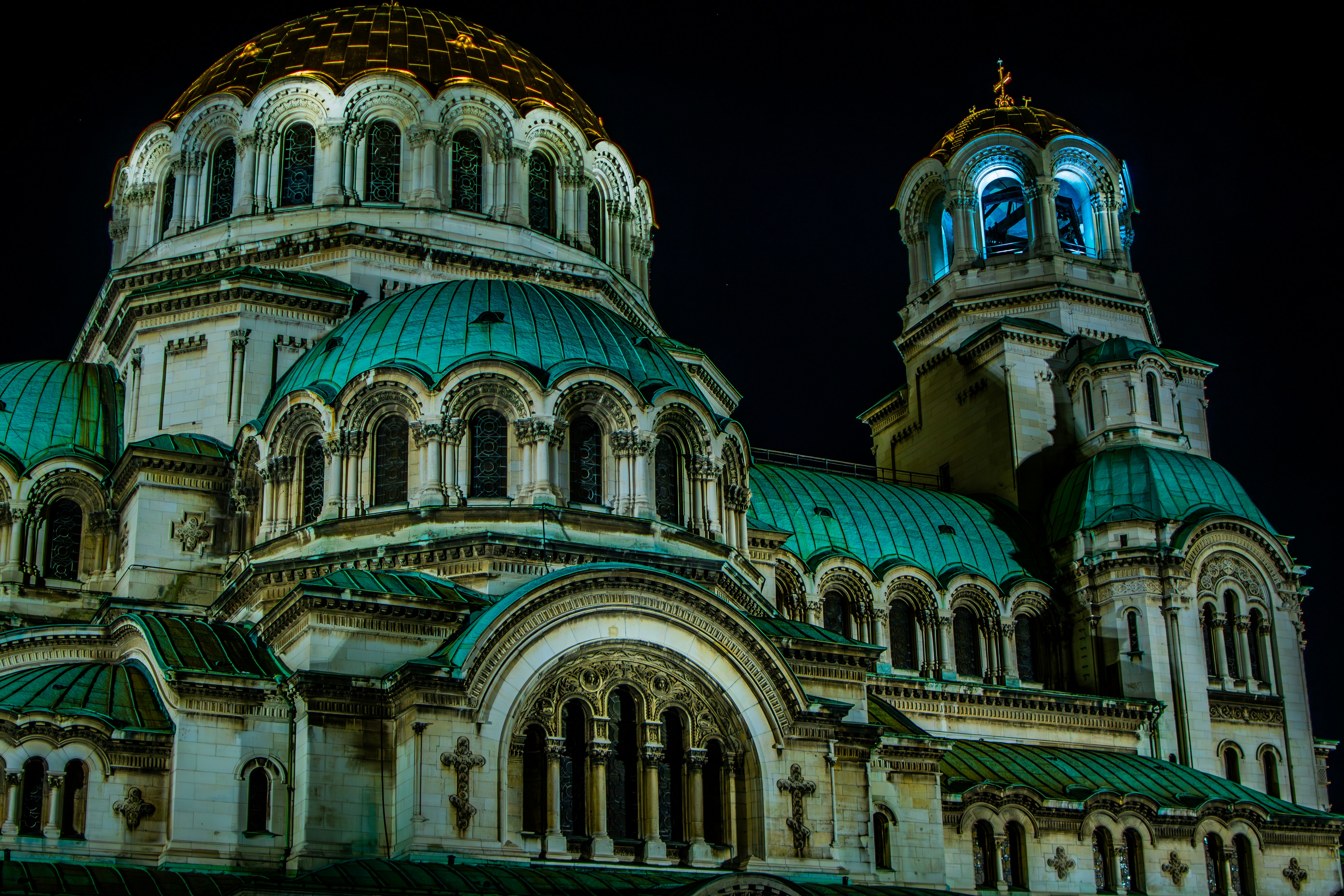 Moonlit Domes: Nighttime Detail of a Green-Tiled Cathedral