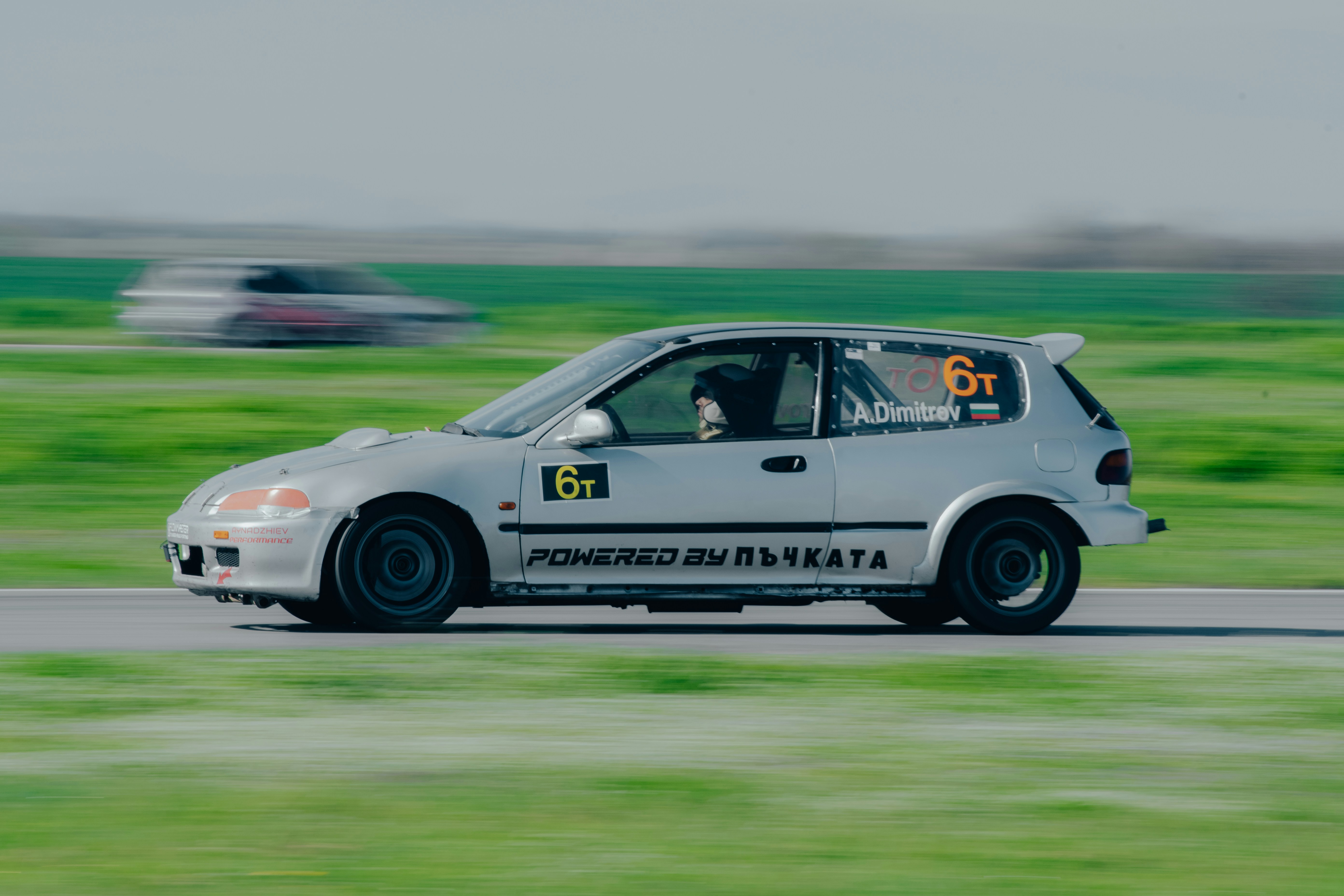 Racing Silver: A Compact Car in Full Throttle