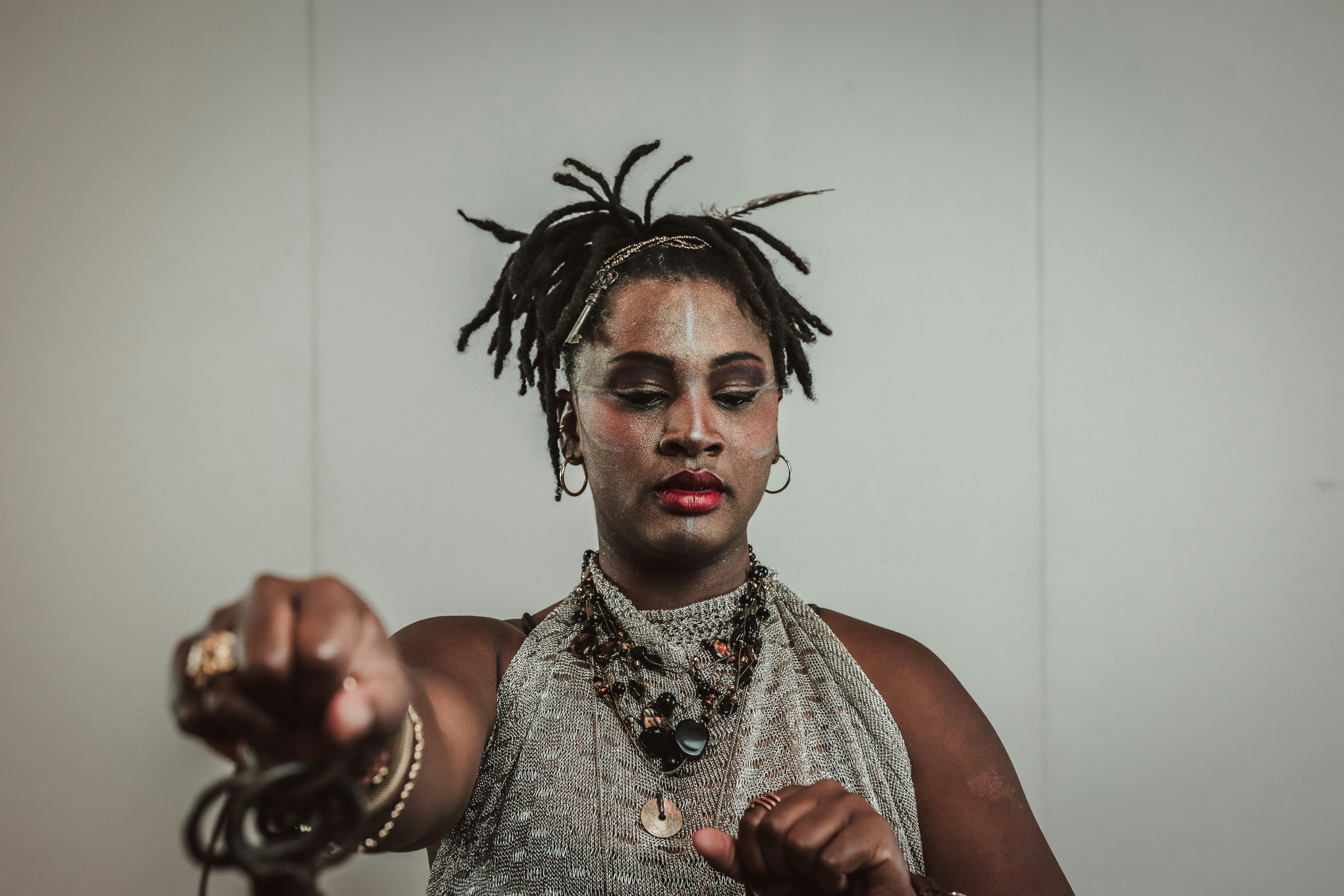 Bold ritual: a close-up of jewelry-clad artist in textile halter