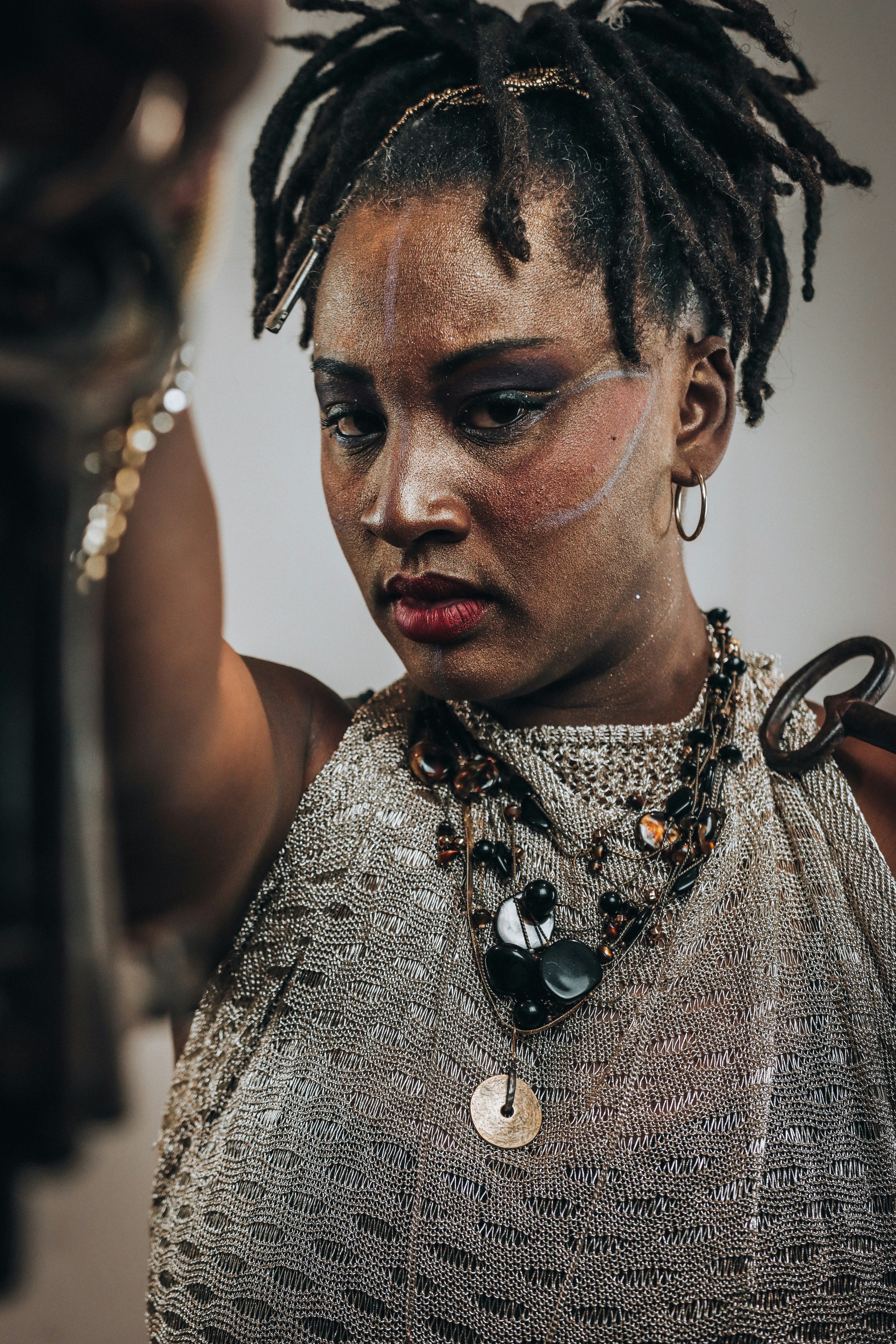 Face in Focus: Sculpted Expression Amid Metallic Adornments