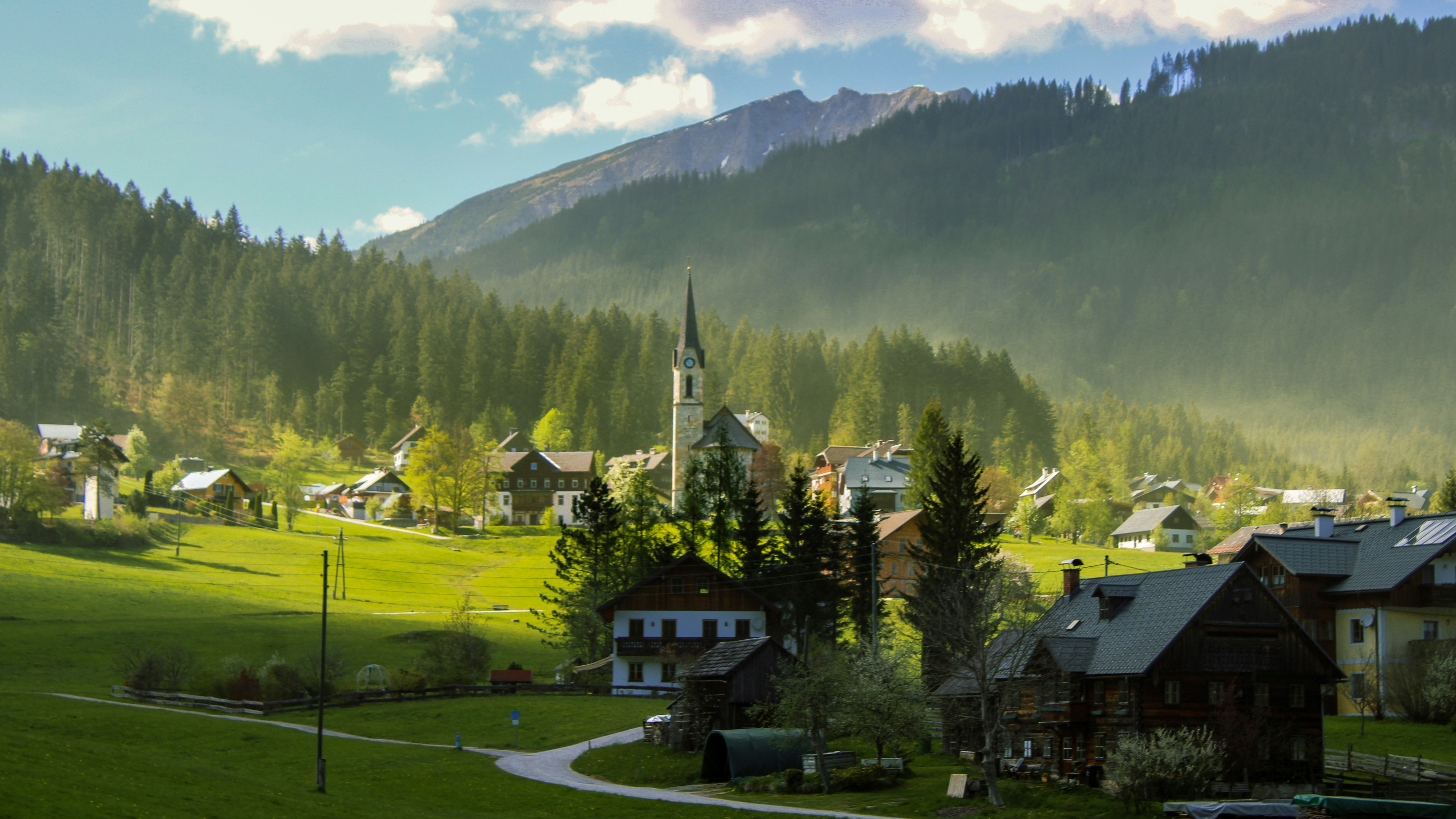 Mountain Village Church Amid Misty Pines at Dappled Morning