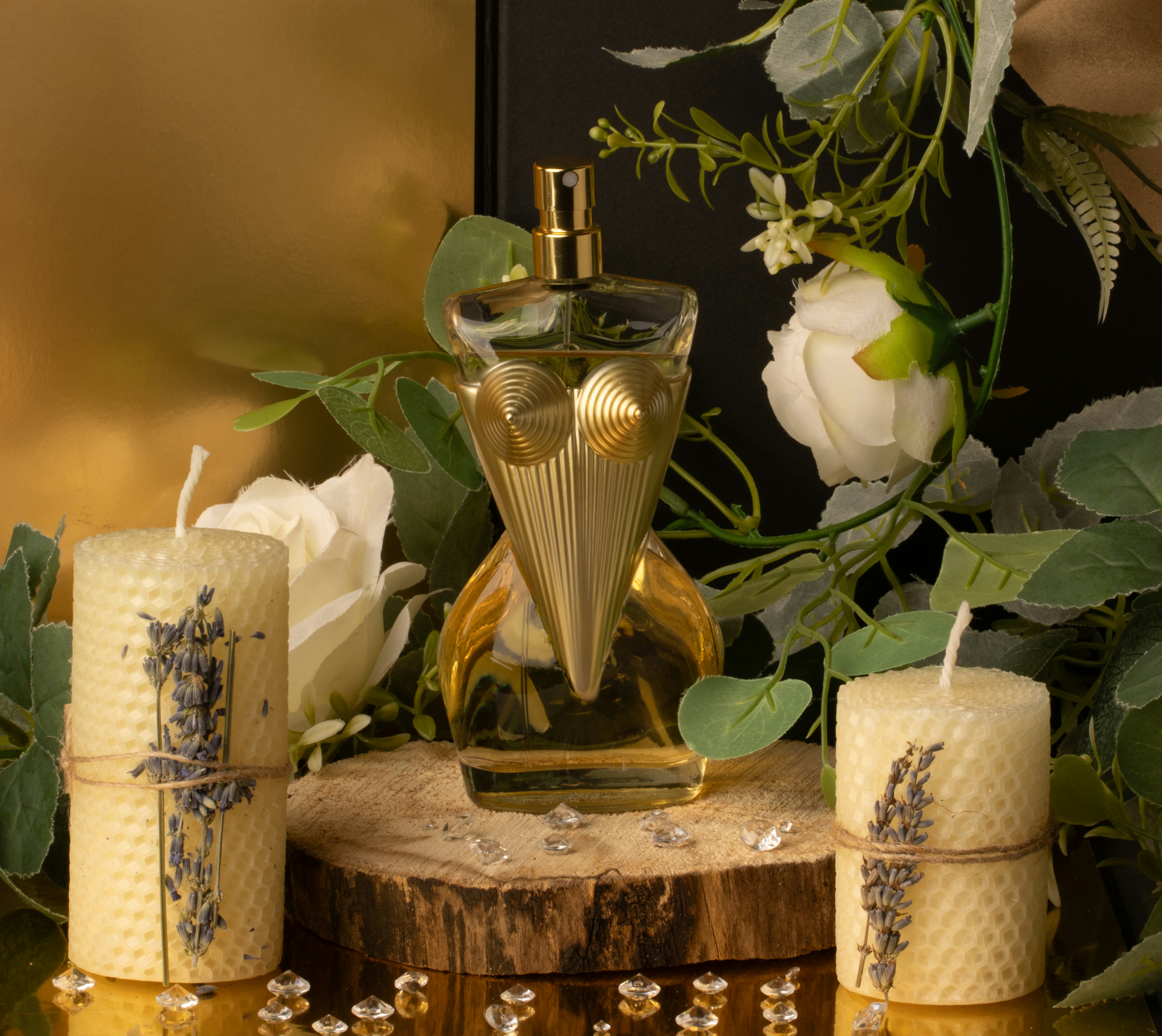 Fragrance on a Rustic Pedestal: A Perfume Bottle Amid Candles and Florals