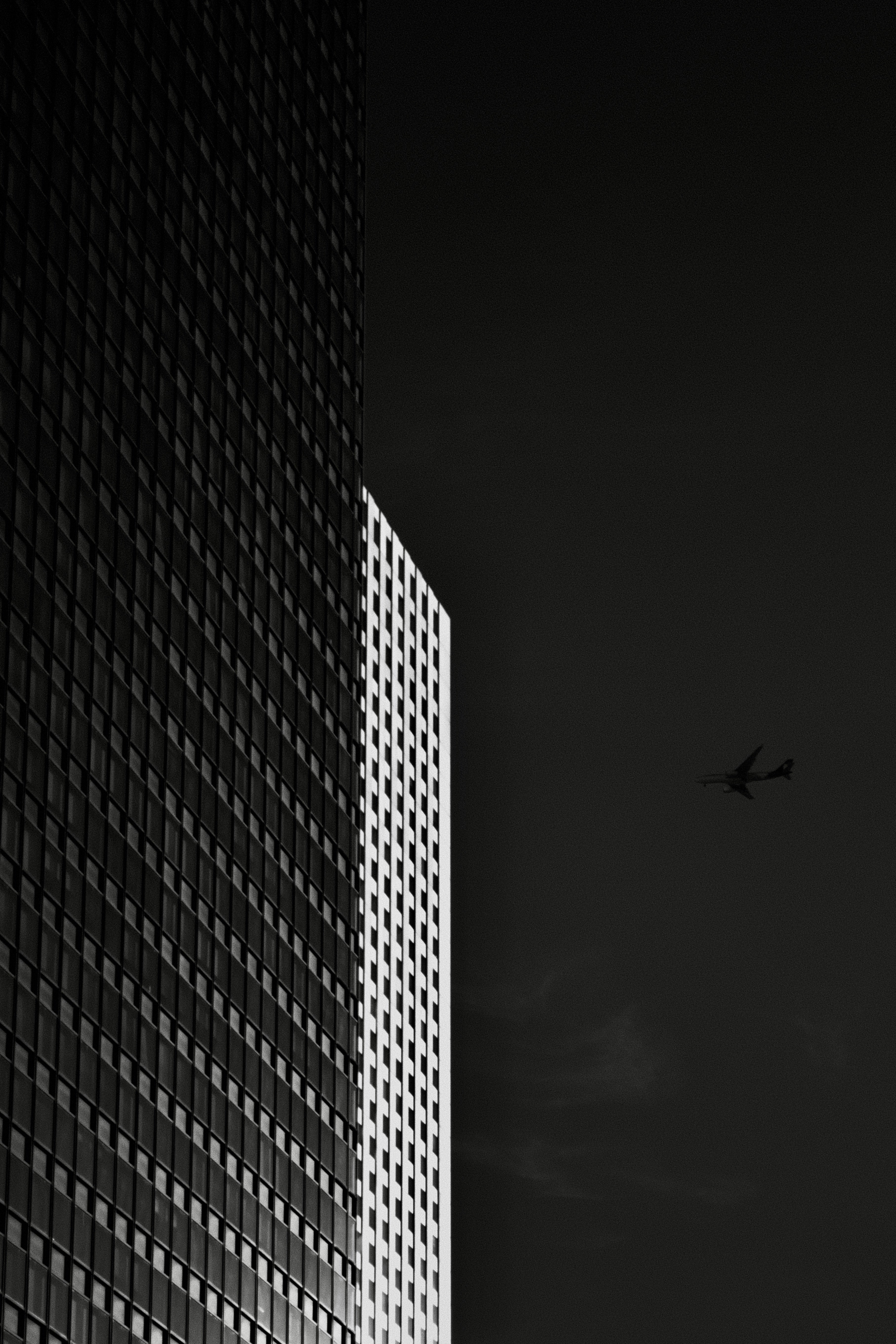 Monochrome Architecture Duel: Sliver of Light on a Facade