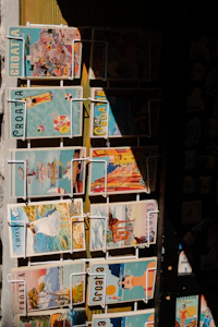 Shoreline of Vintage Travel: A Rack of Retro Postcards in Sunlit Shadow