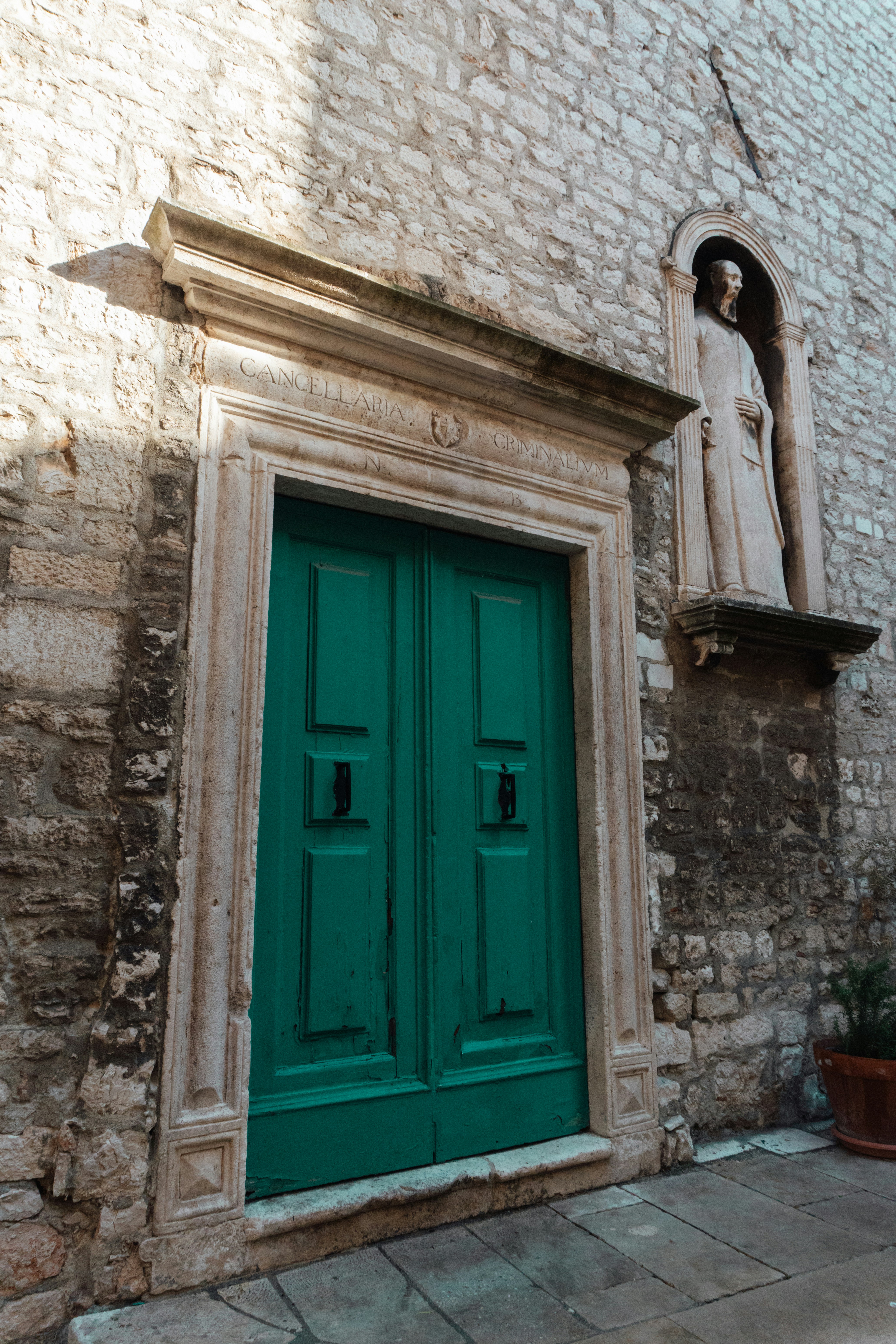 Emerald Door beneath a Stone Guardian