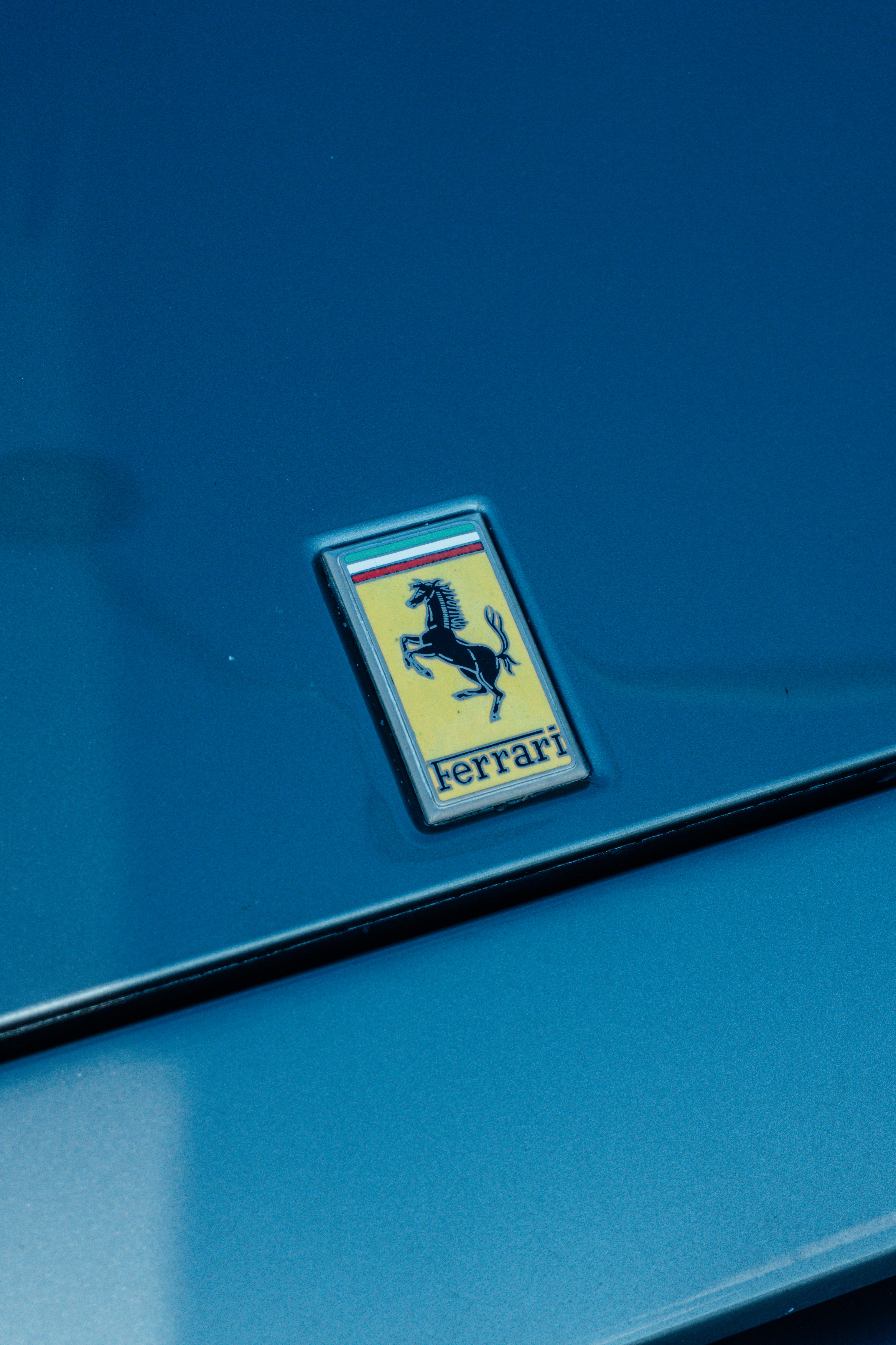 Prancing Emblem: The Ferrari Badge on a Quiet Car Hood