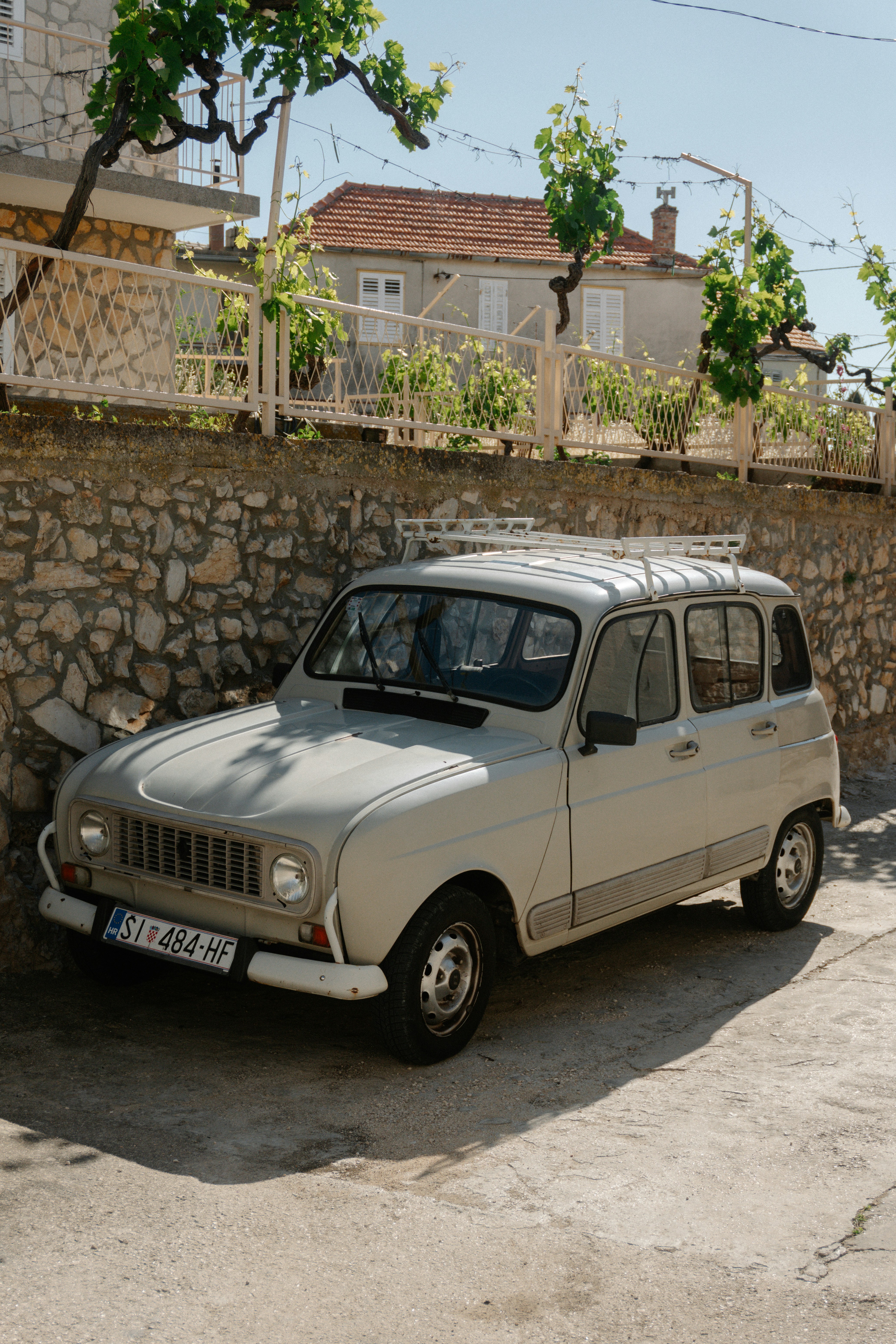 Vintage Renault Adventures: Classic Car and Sunlit Courtyard