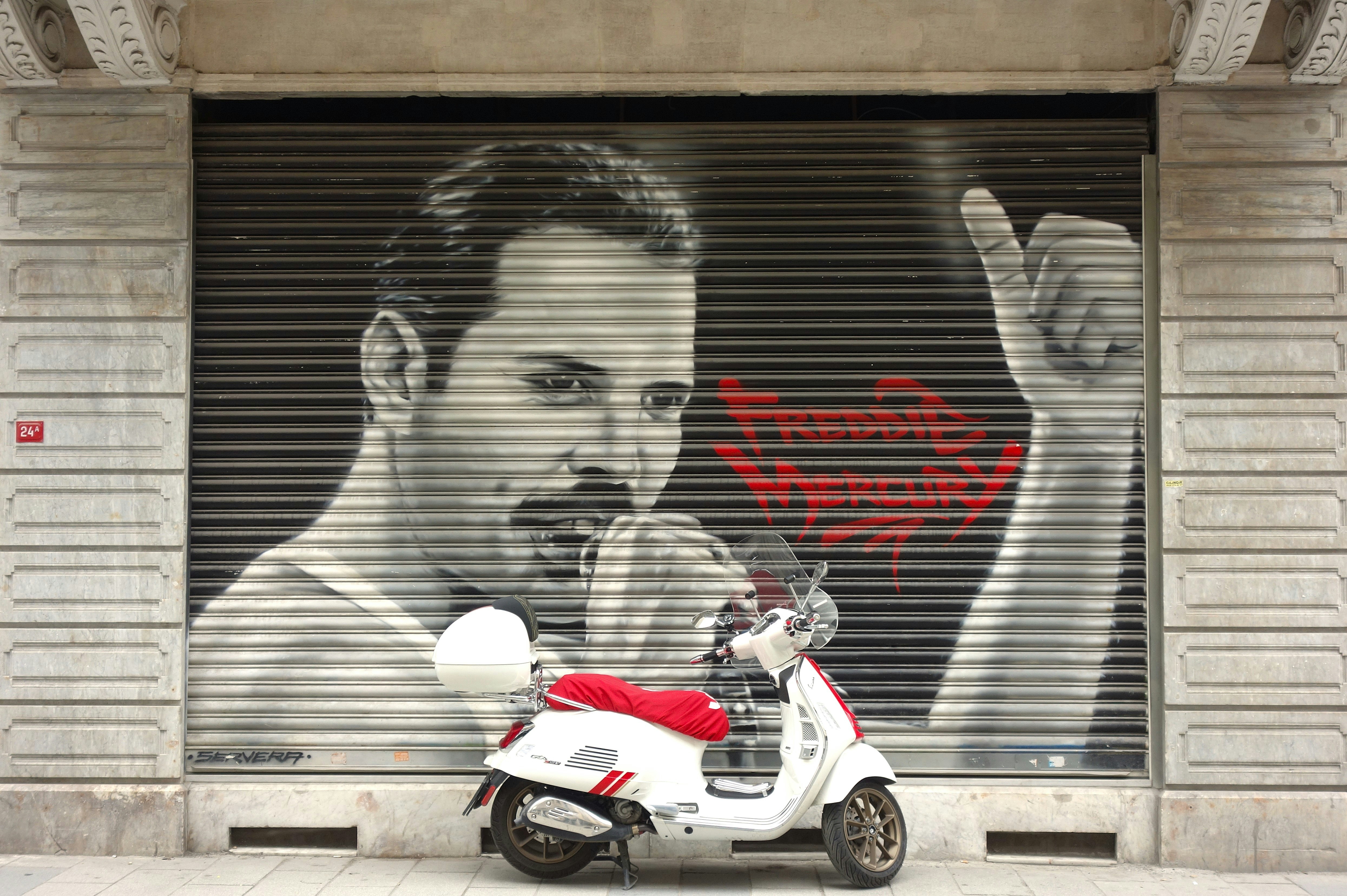 Scooter in Front of a Portrait: A Street-View Moment