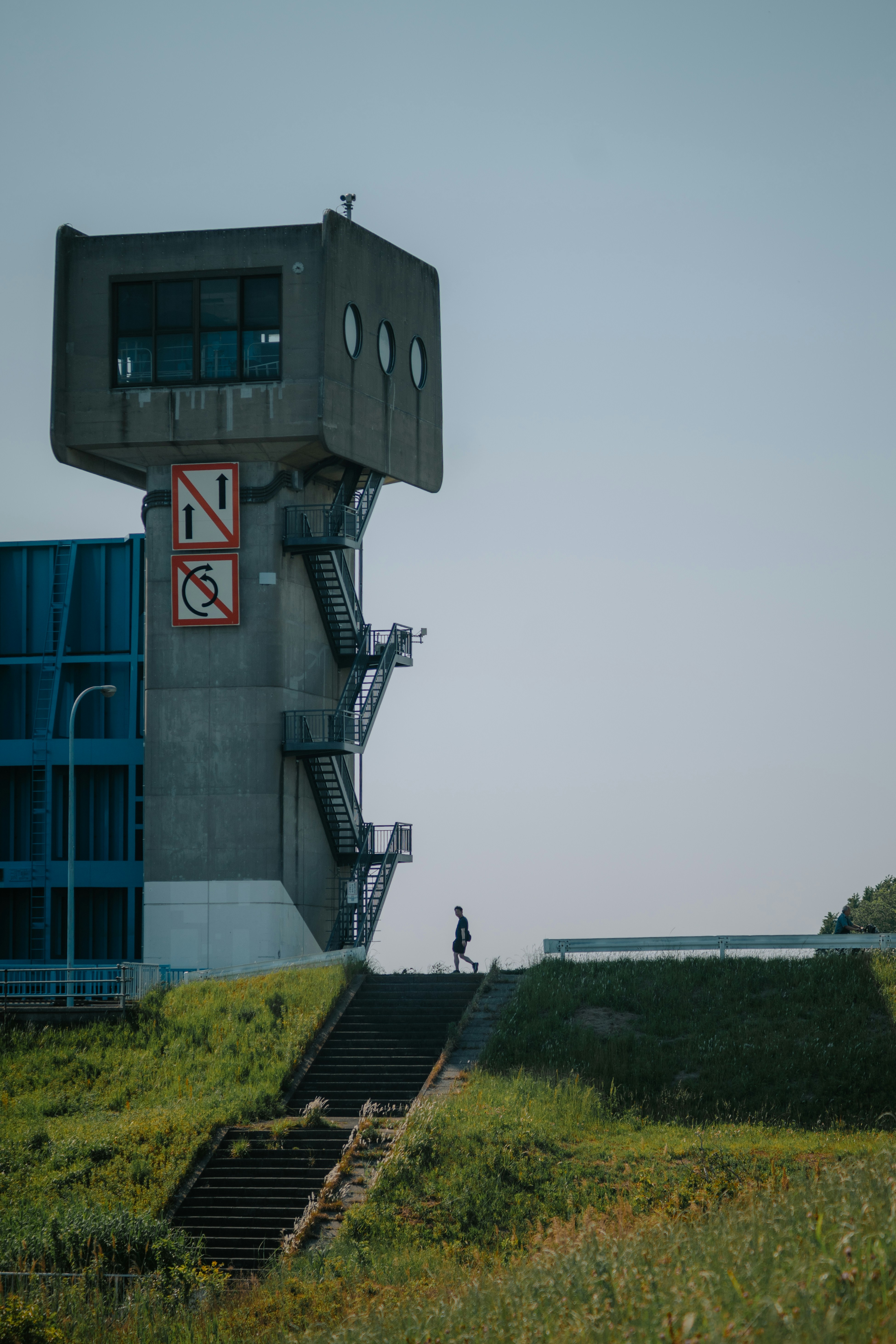Silent Figure at the Steps: A Keeper Overlooking the Hill