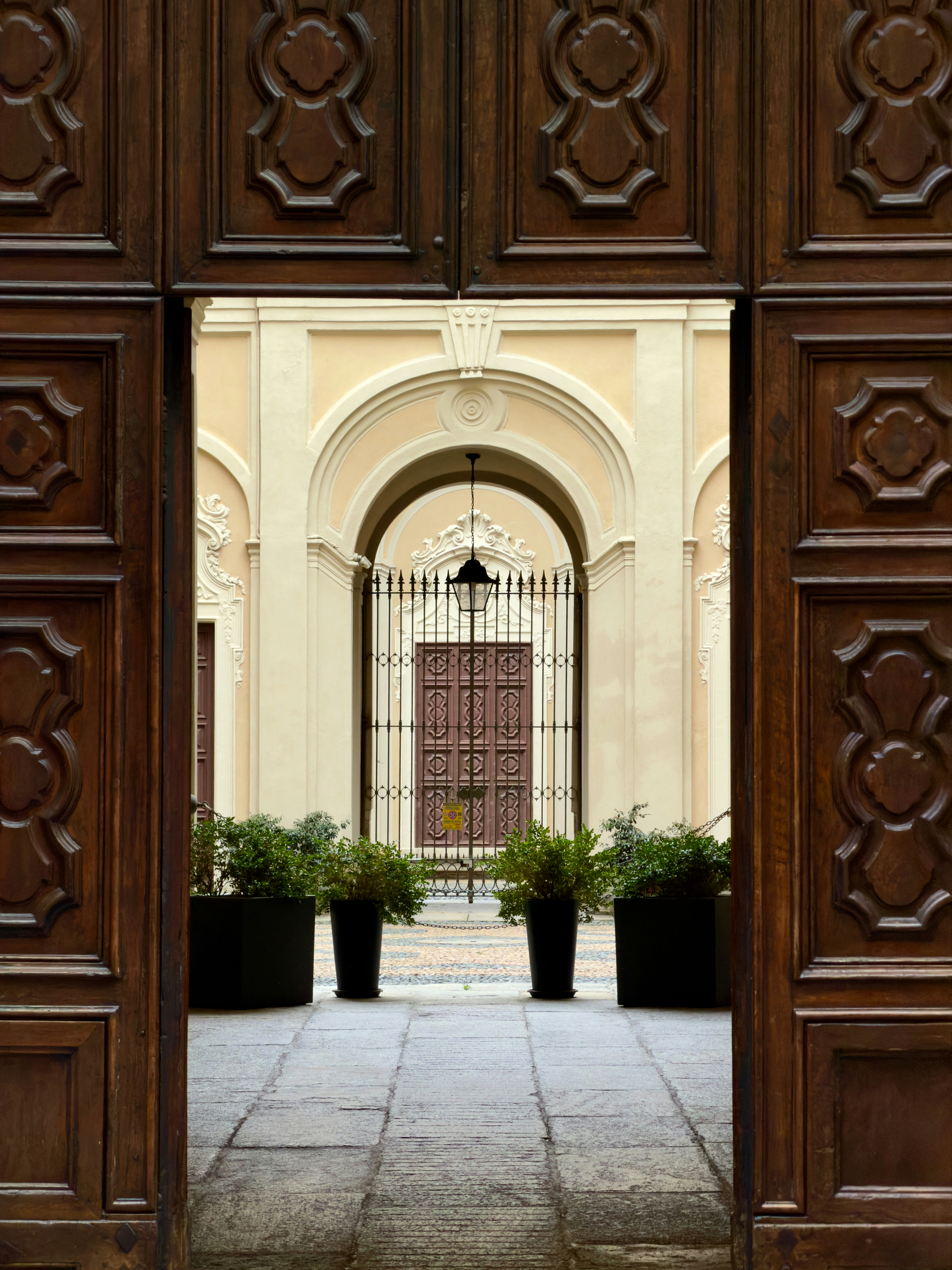 Doorway to a Quiet Courtyard: Framed Arch with Iron Gate