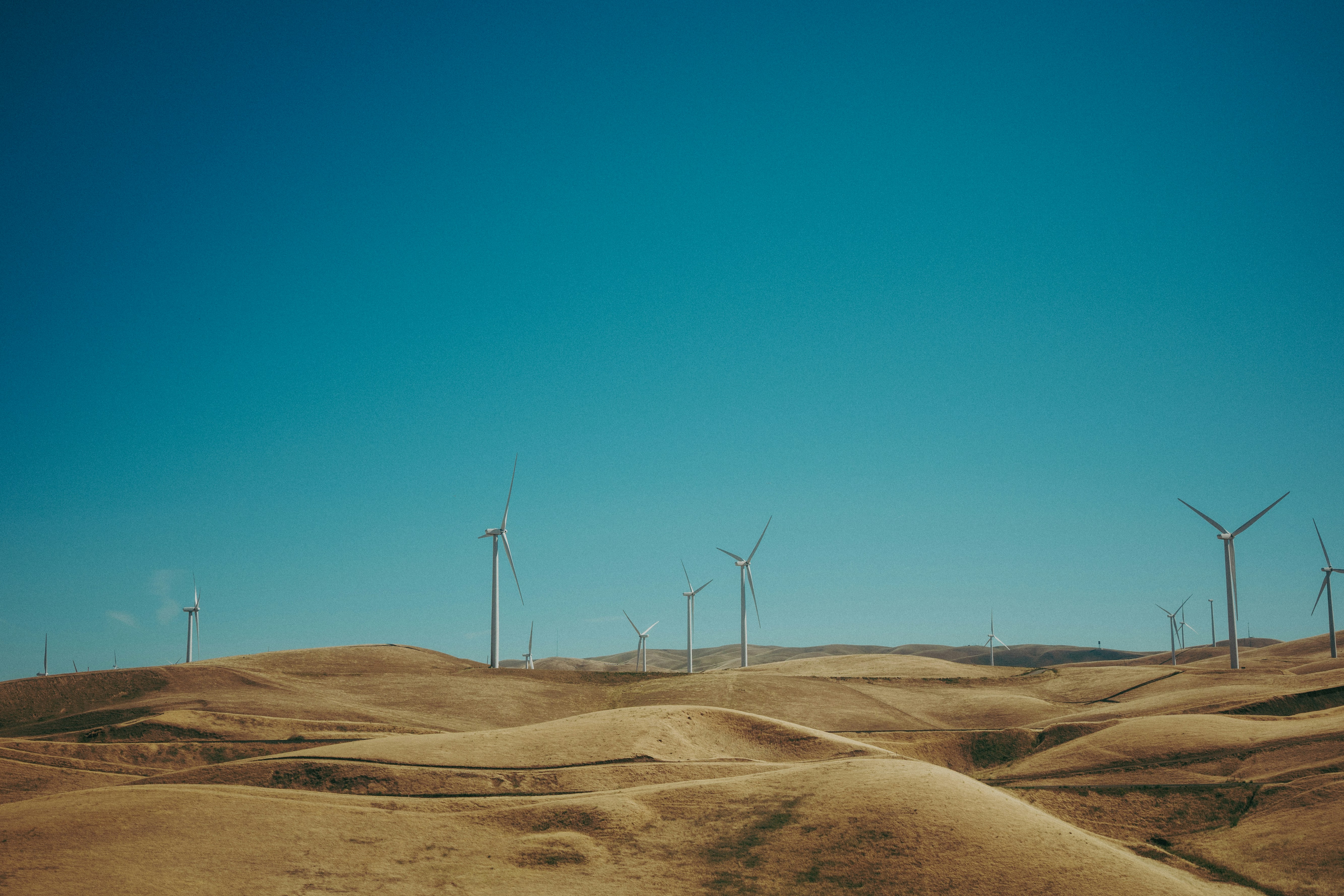 Windward Horizon: Quiet Hills with Distant Turbines