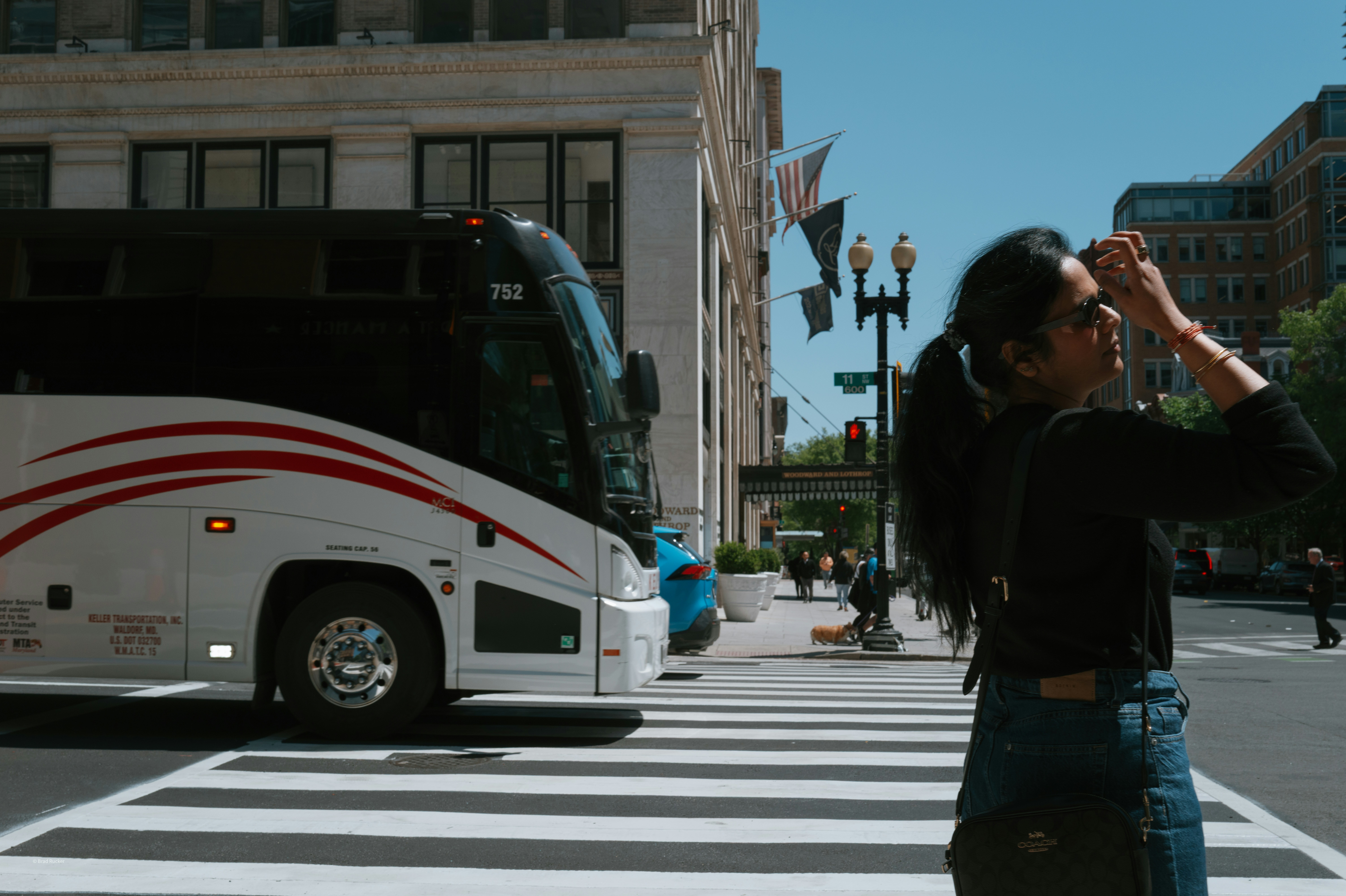 Street Muse: A Woman Adjusts Her Hat Against a City Backdrop