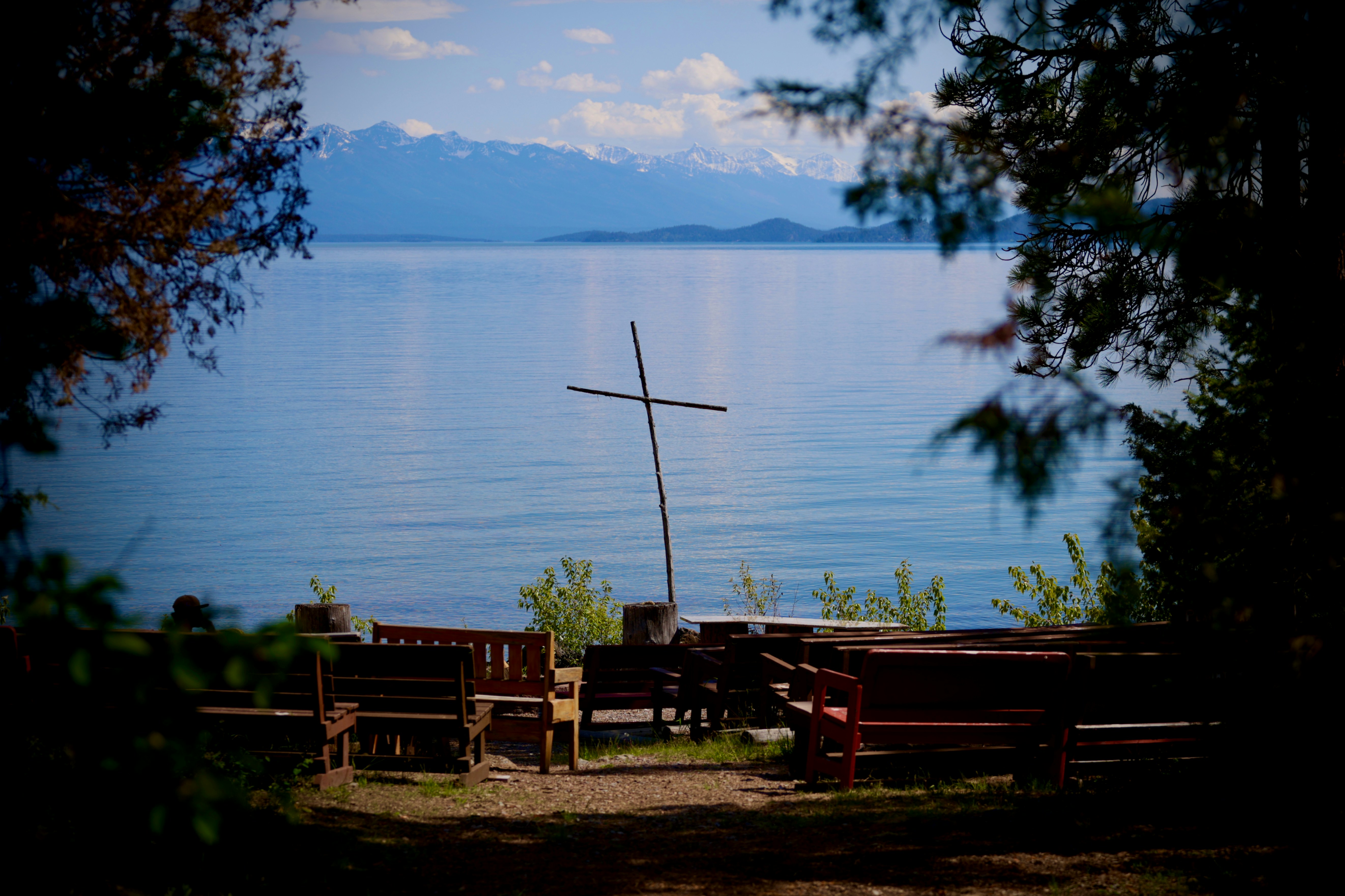 A Quiet Shoreline Shrine: A Lone Cross Overlooking a Calm Lake