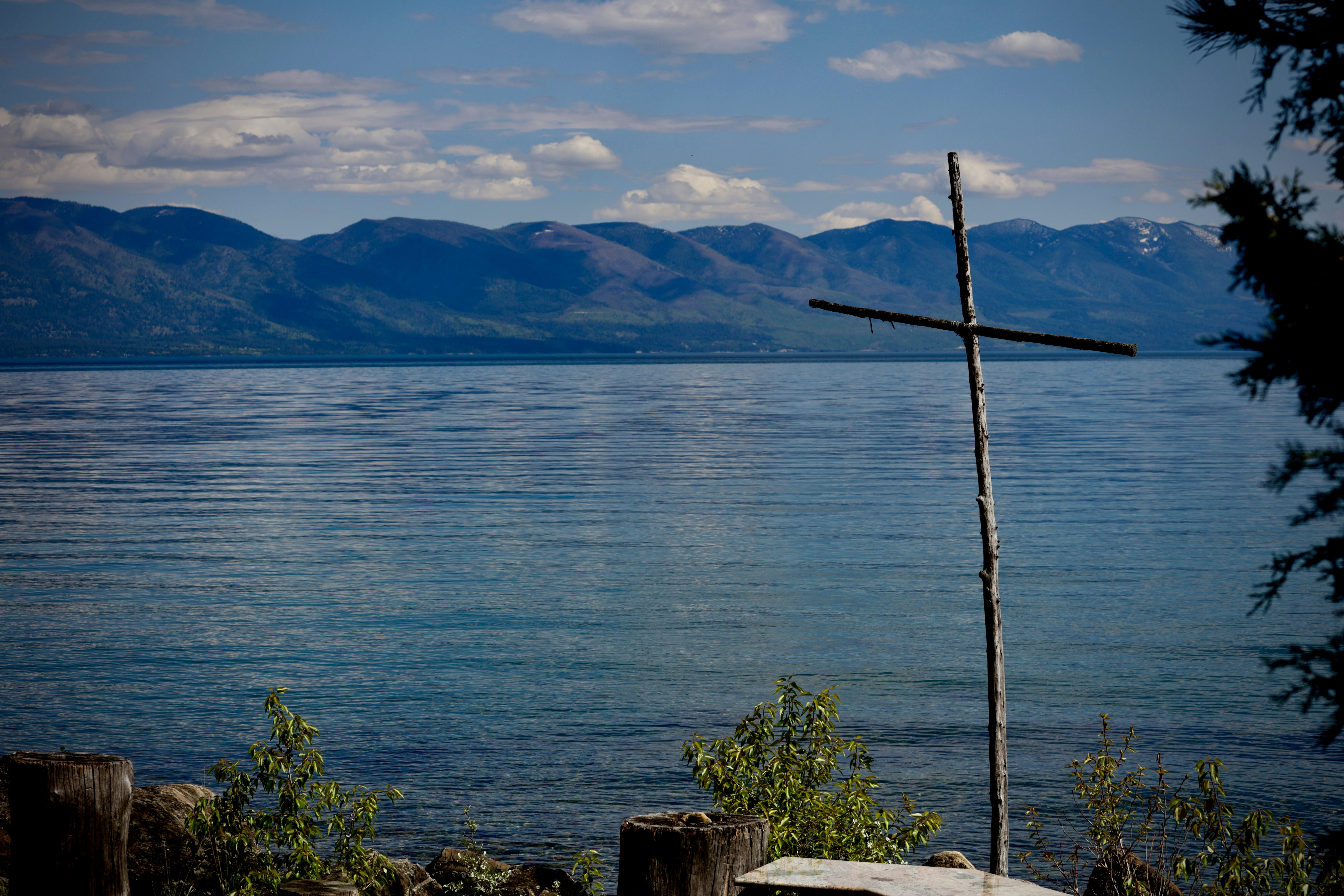Cross on the Shore: A Quiet Vista by the Lake