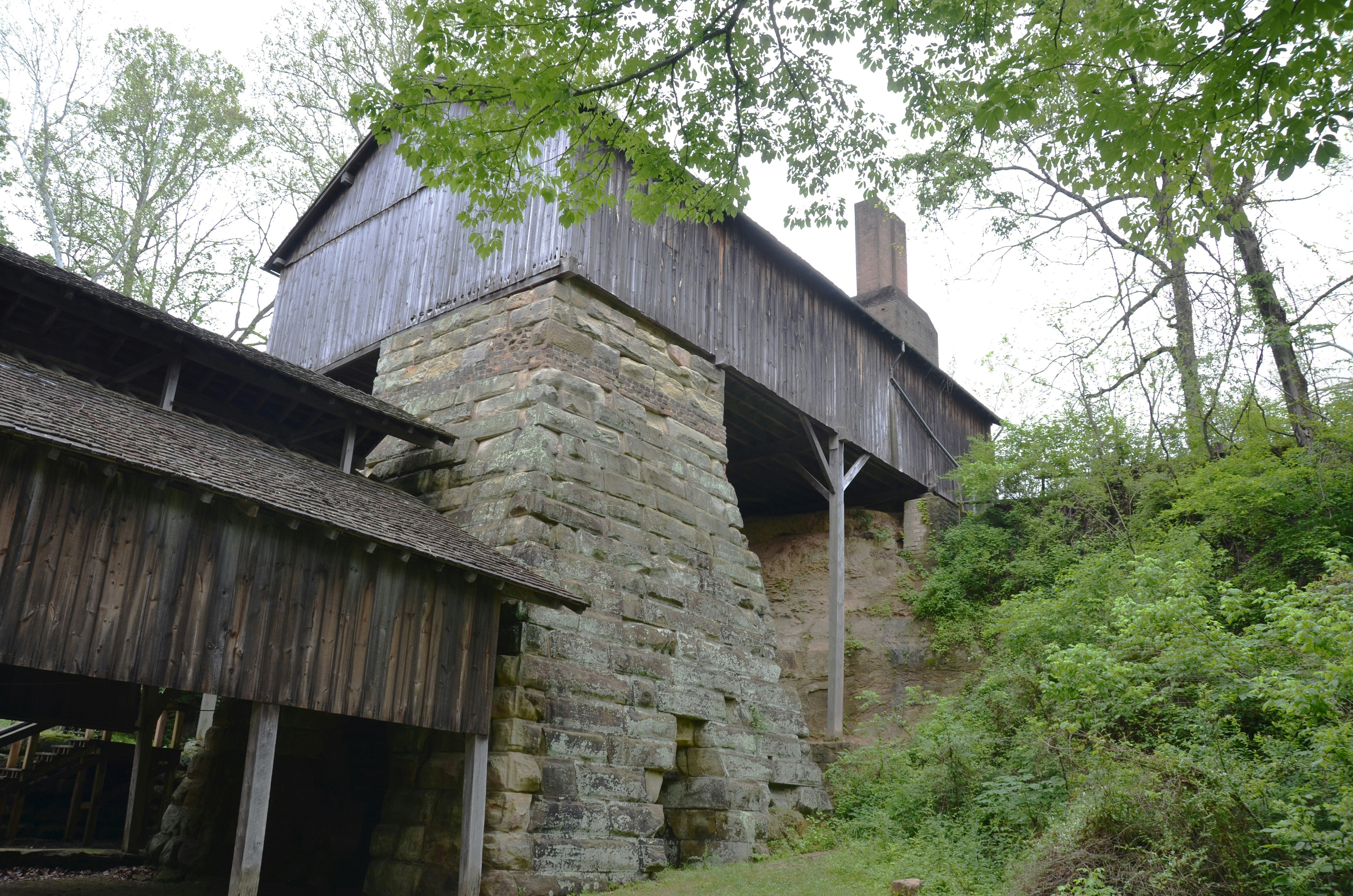 Old Mill on a Stone Rise Reaching into a Lush Green Canopy