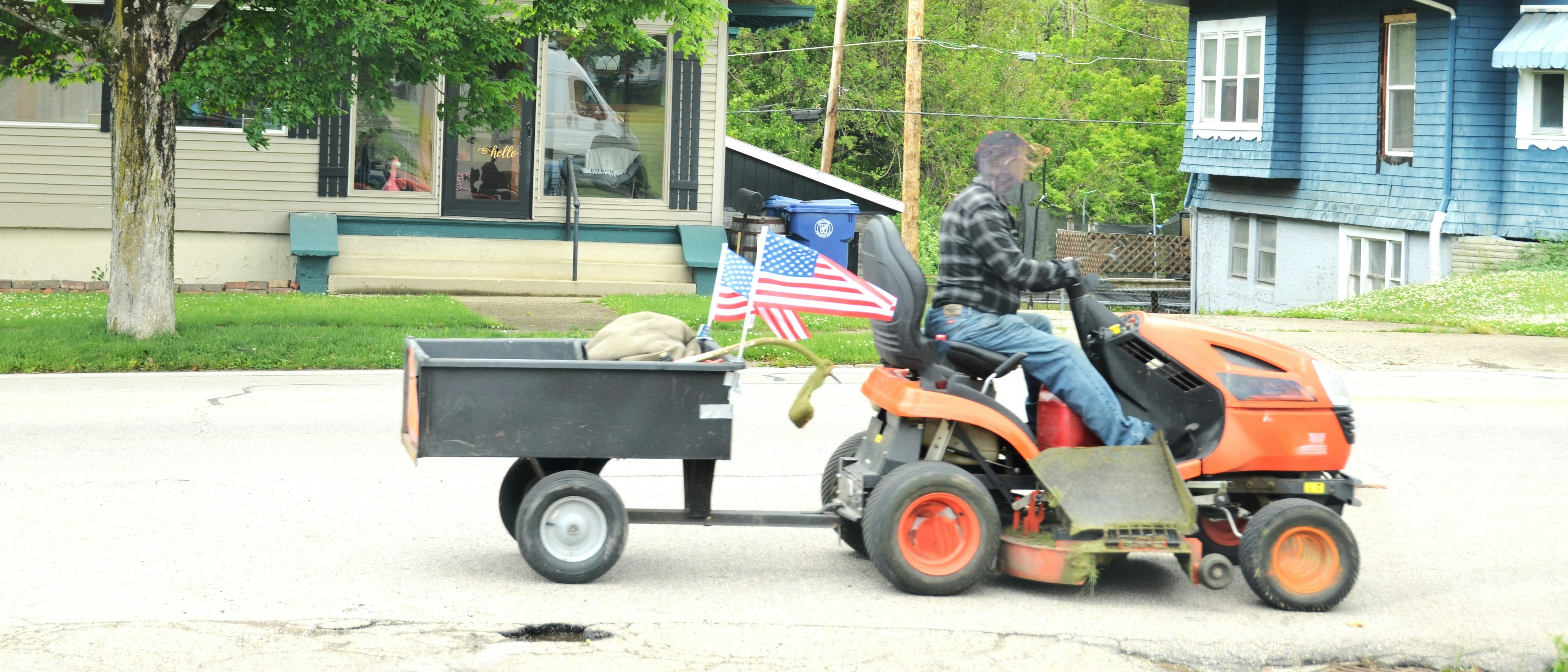 Lawnmower Rider in a Small-Town Parade of Greens