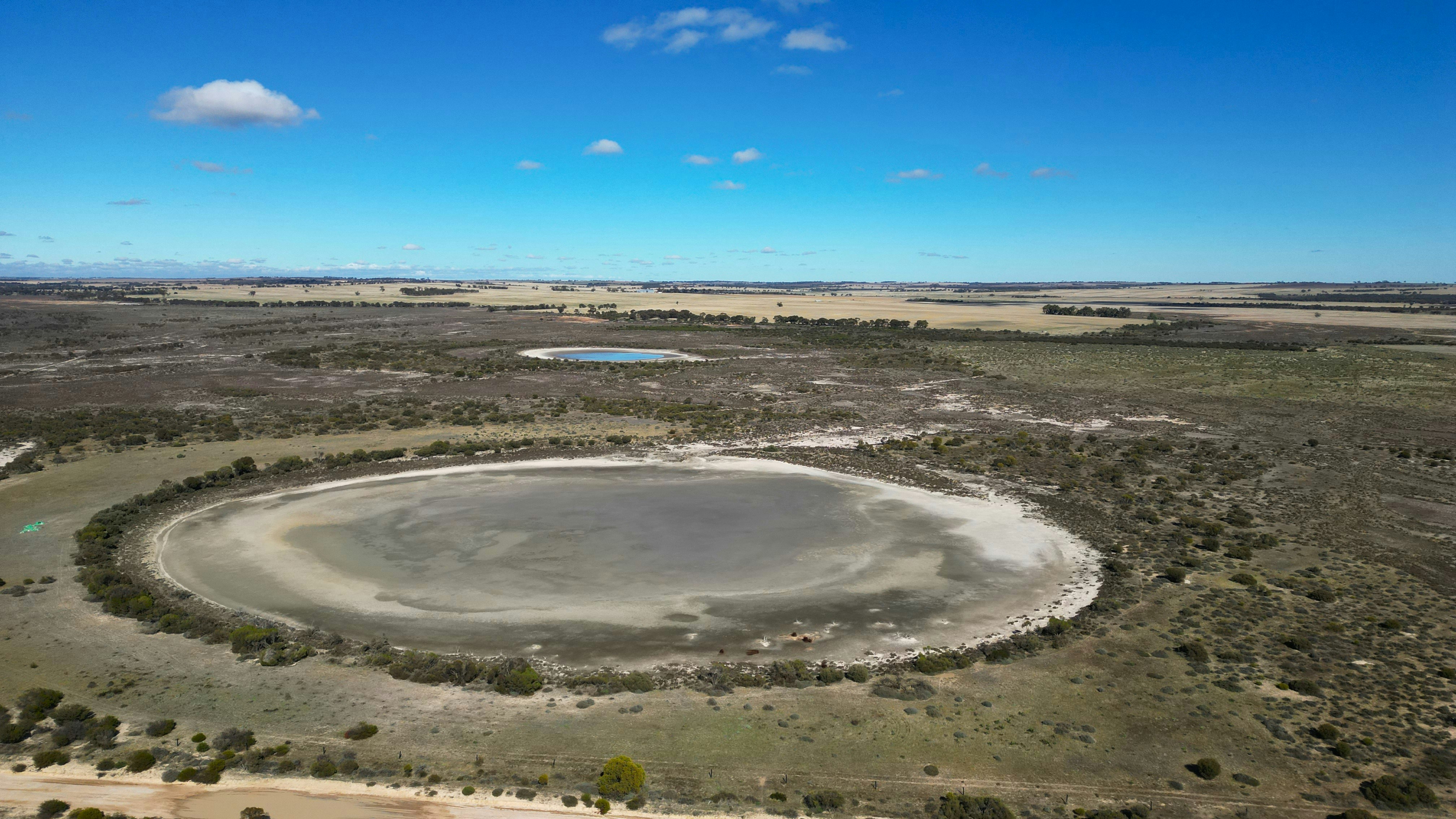 Salt Pan Ring Under Wide Blue: A Desert Flat with A Quiet Lagoon