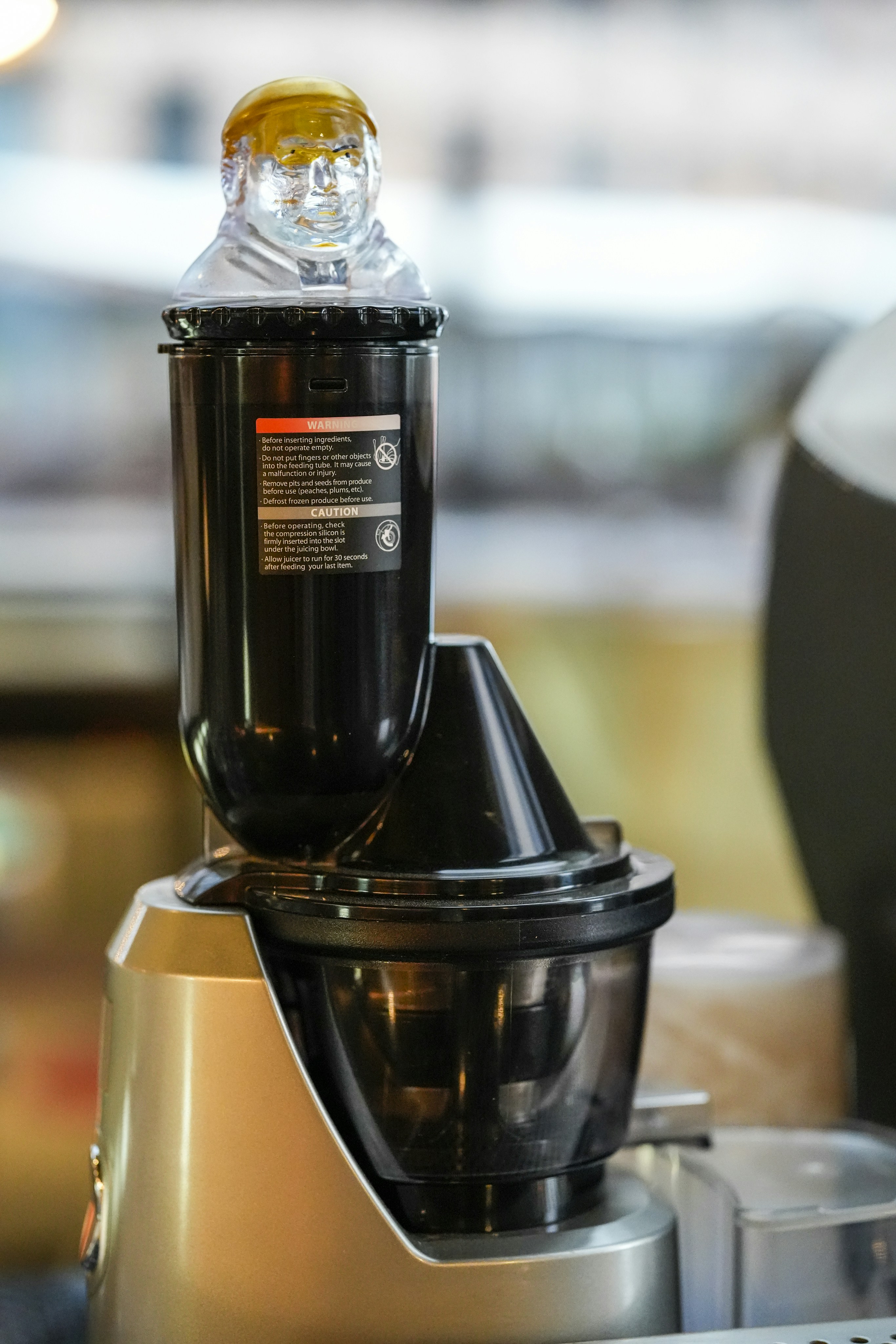 Juiced grinder in chrome ritual: close-up of a modern juicer's top chamber
