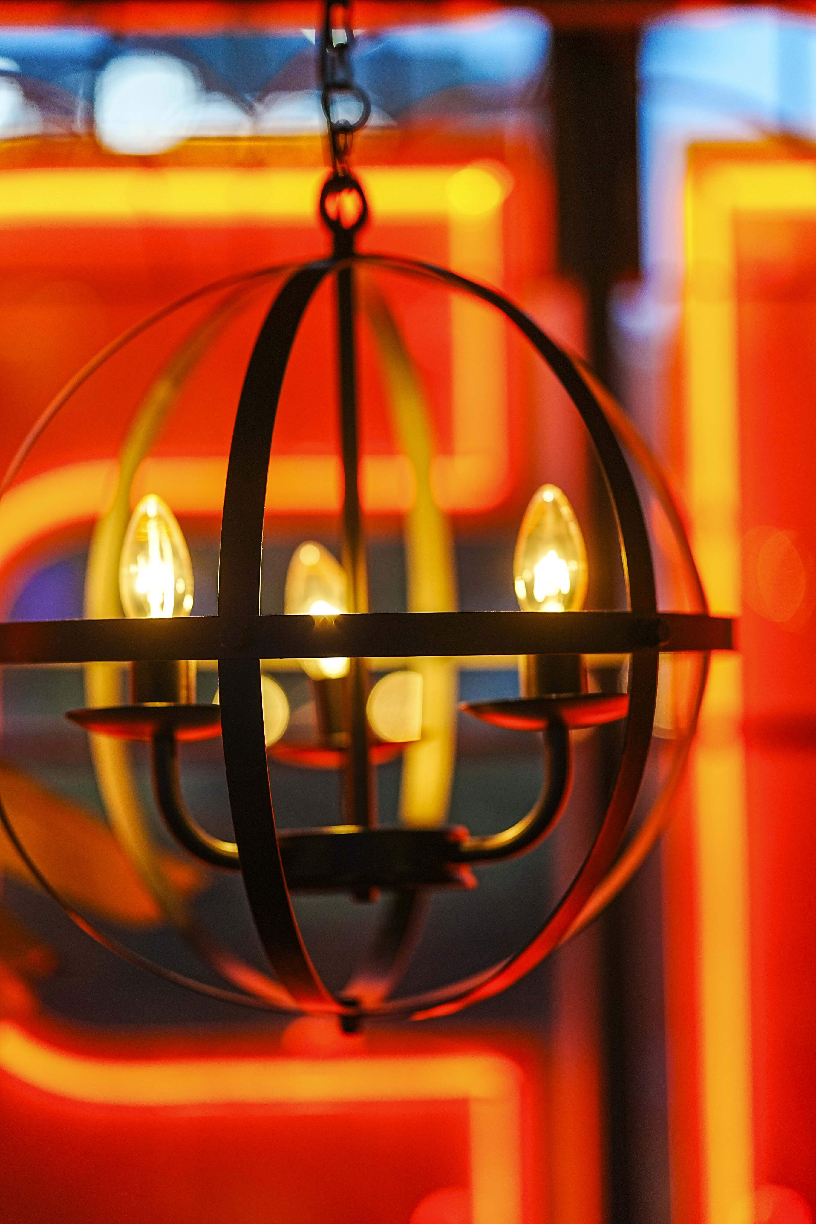 Orbital Ember: Neon Halo Around a Hanging Candelabrum