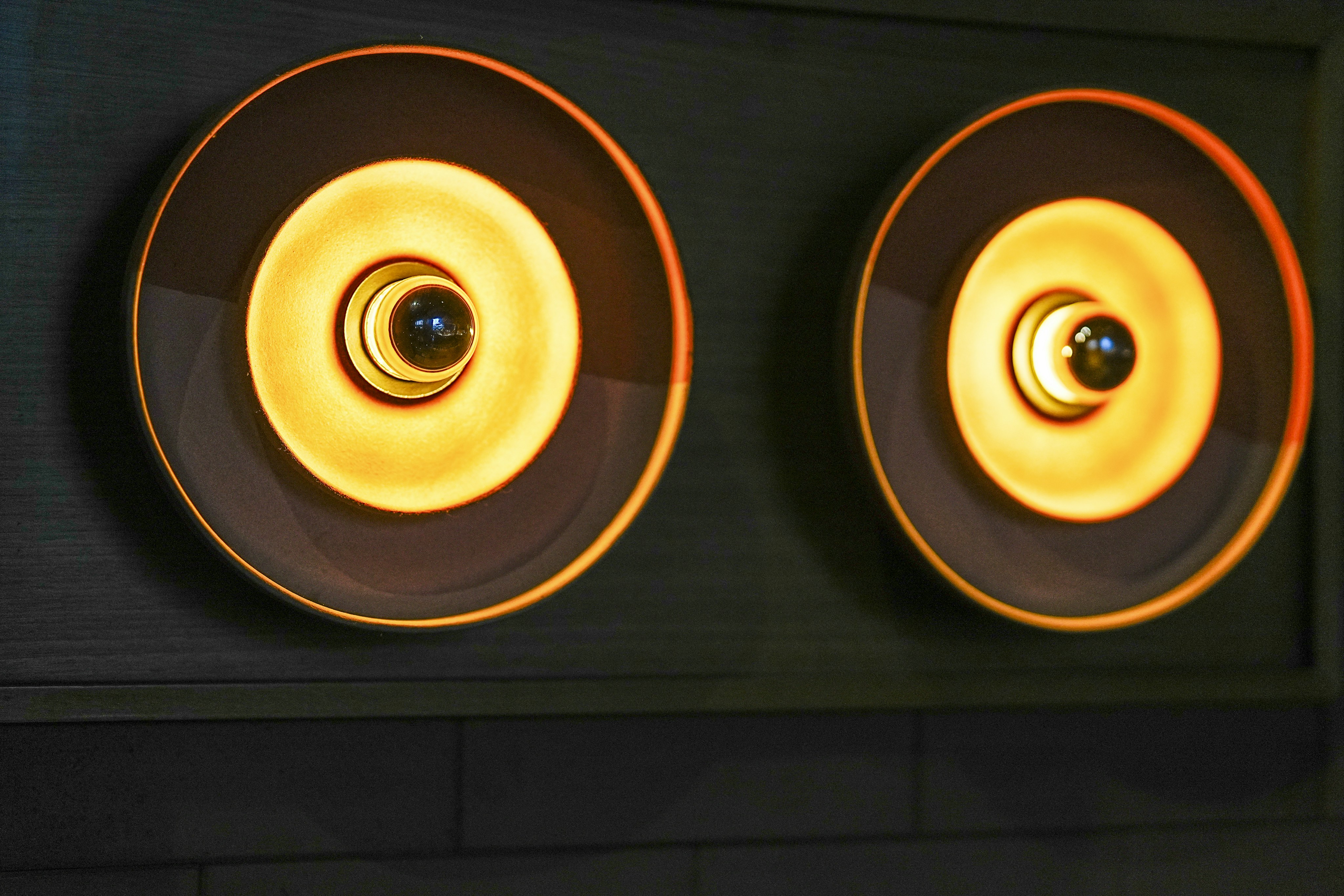 Twin Orange Disks: A Close-Up of Illuminated Speaker Lenses