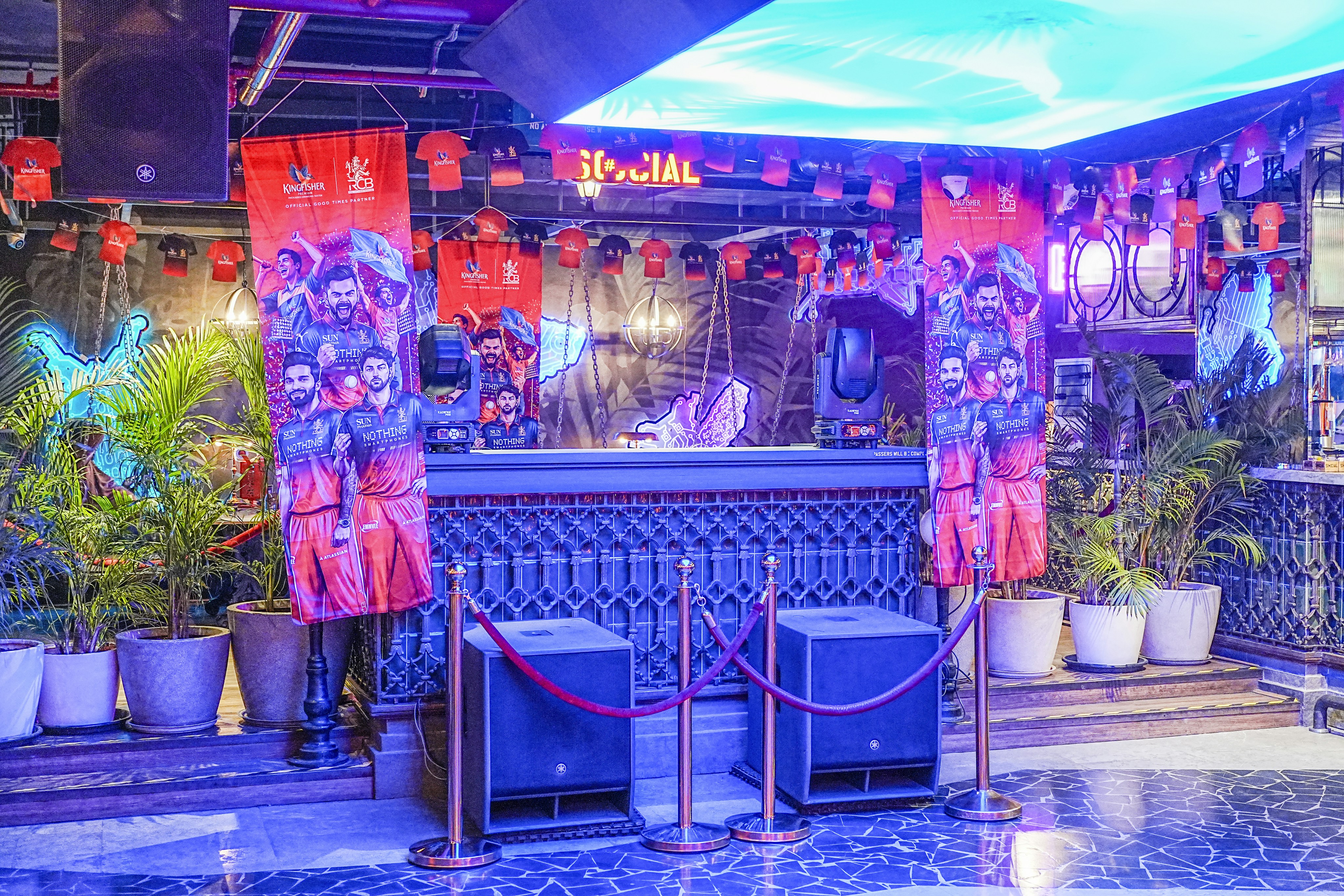 Neon Stage Front: A Vibey Club Scene with Red Banners and Blue Ambient Light