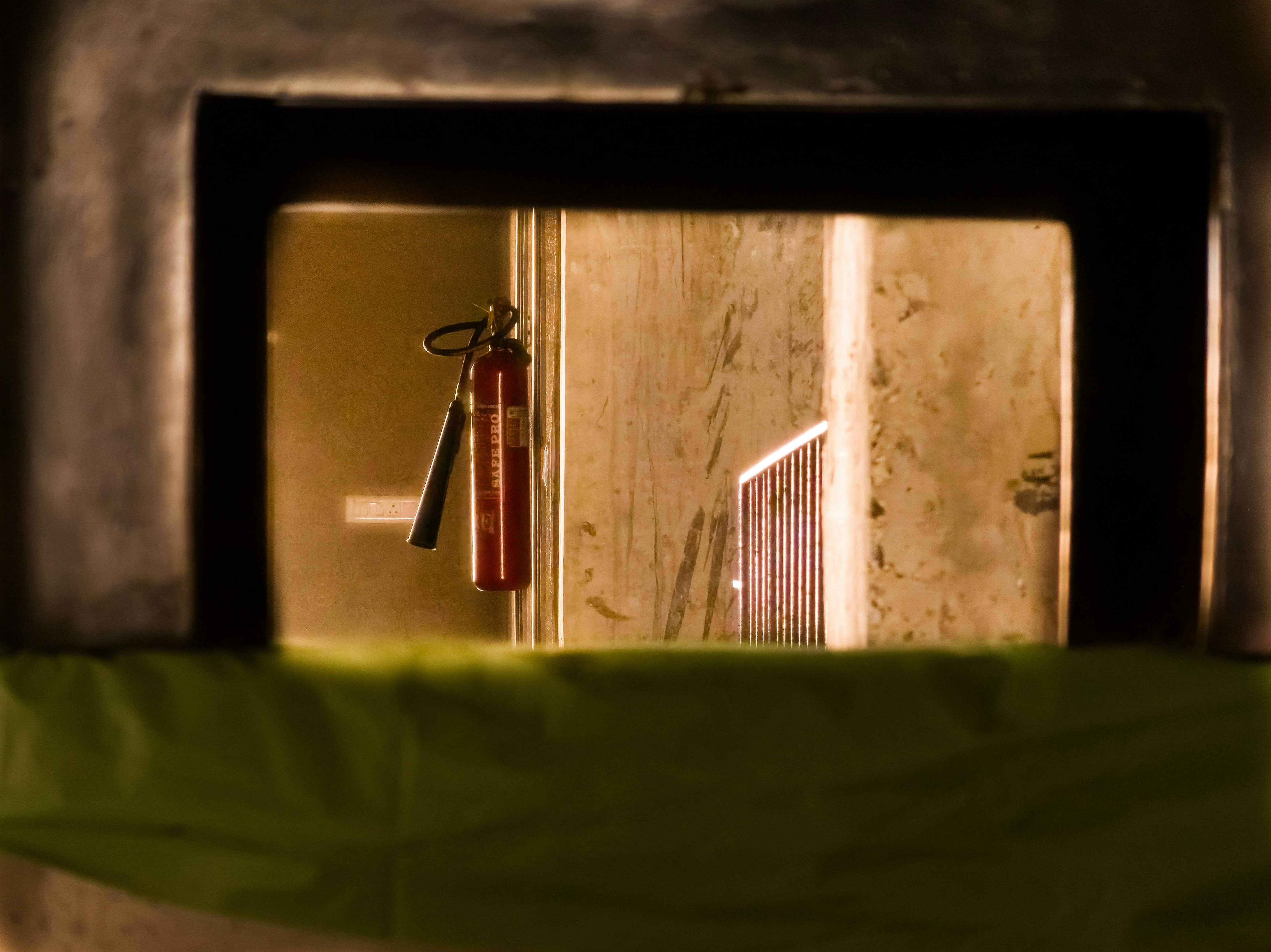 Vent from the Void: Fire Extinguisher in a Dim Corridor