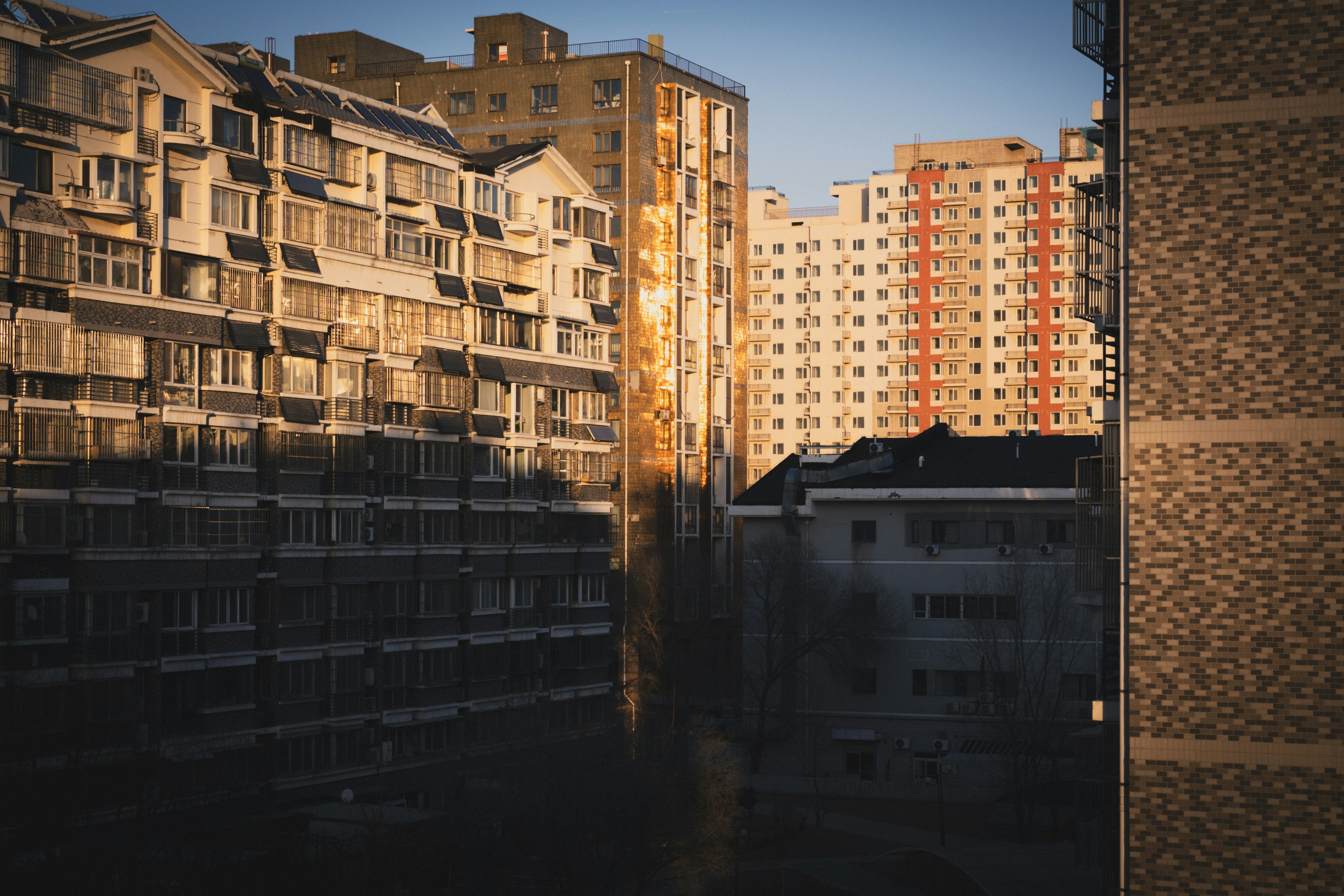 Golden Hour Between Towers: A Quiet Street Emerges in Sunset Light