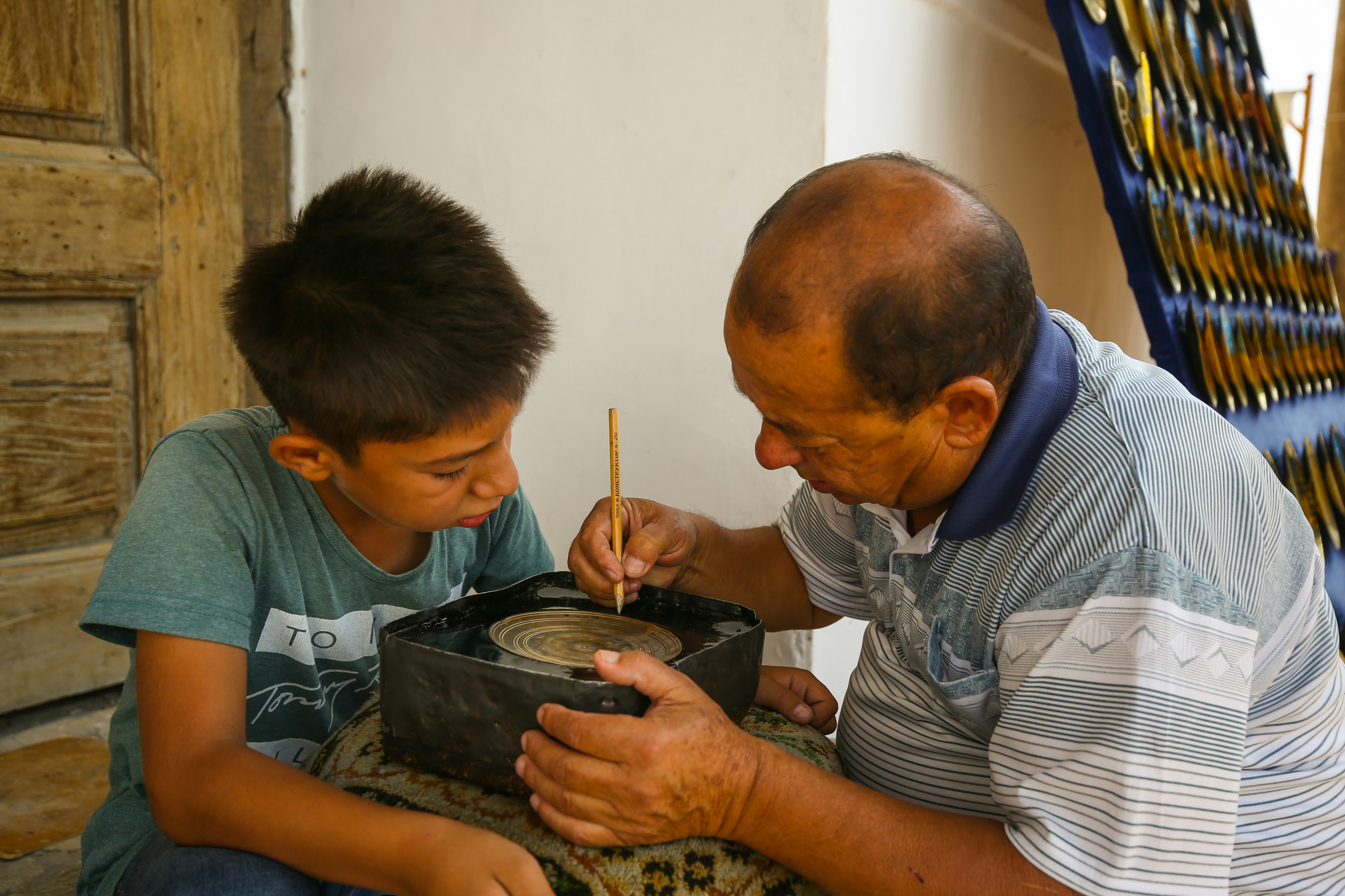 Hands and Charcoal: A Moment of Shared Craft Between Father and Son