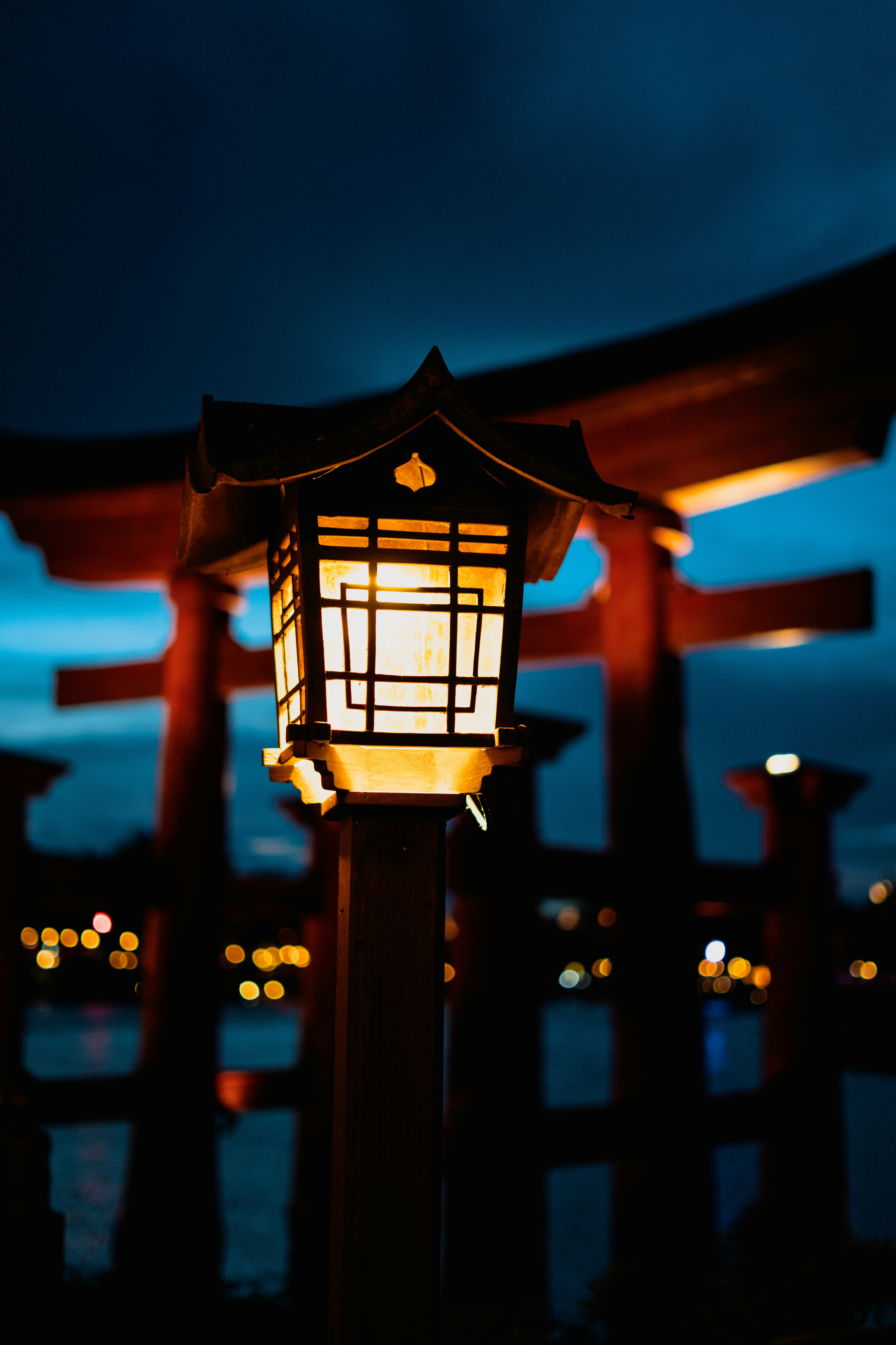 Lantern at the Gate: Warm Glow Under Indigo Sky