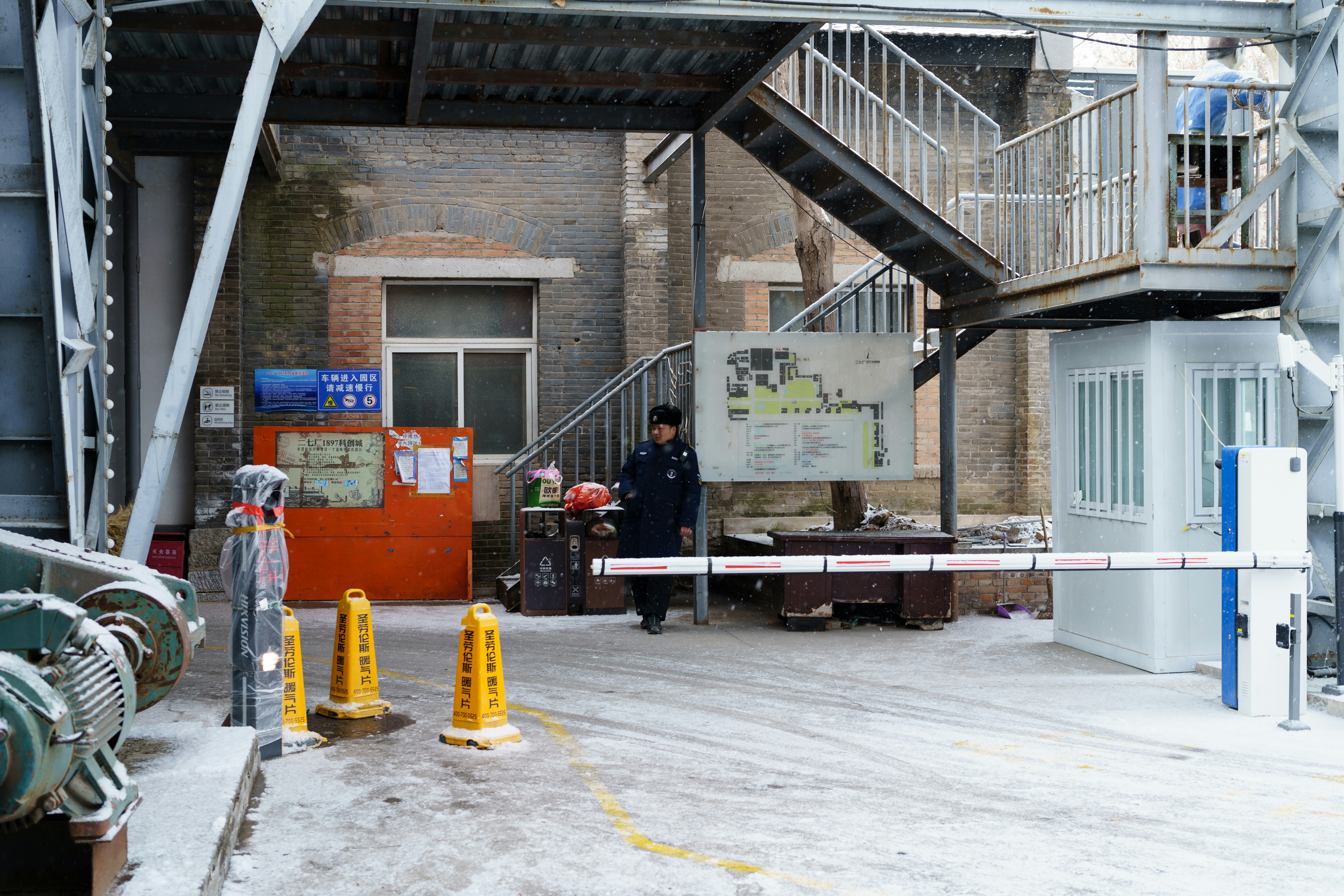 Industrial corridors and security at dusk: a checkpoint under the stairs