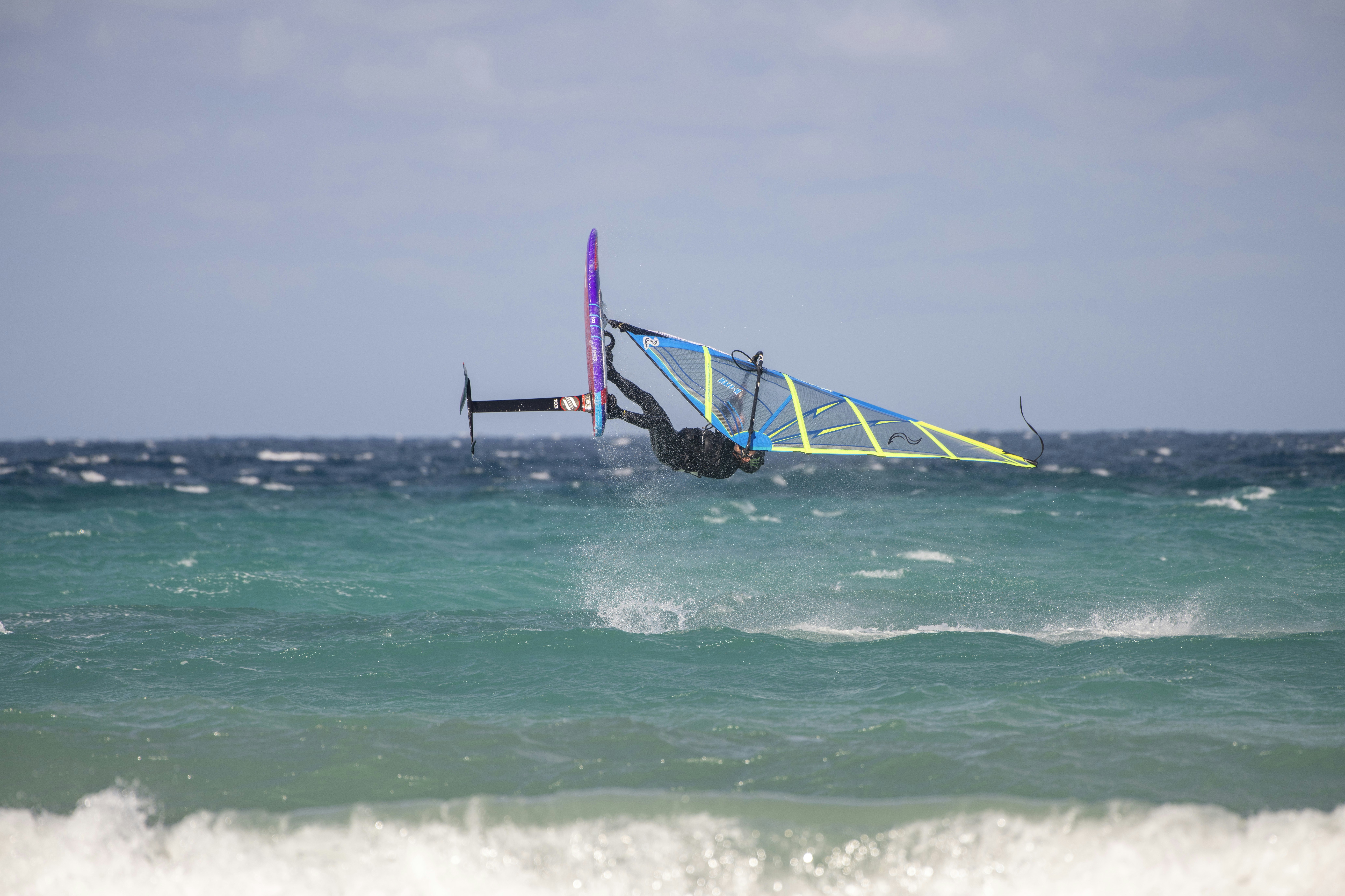Windsurfer Slicing Through Turquoise Breaks
