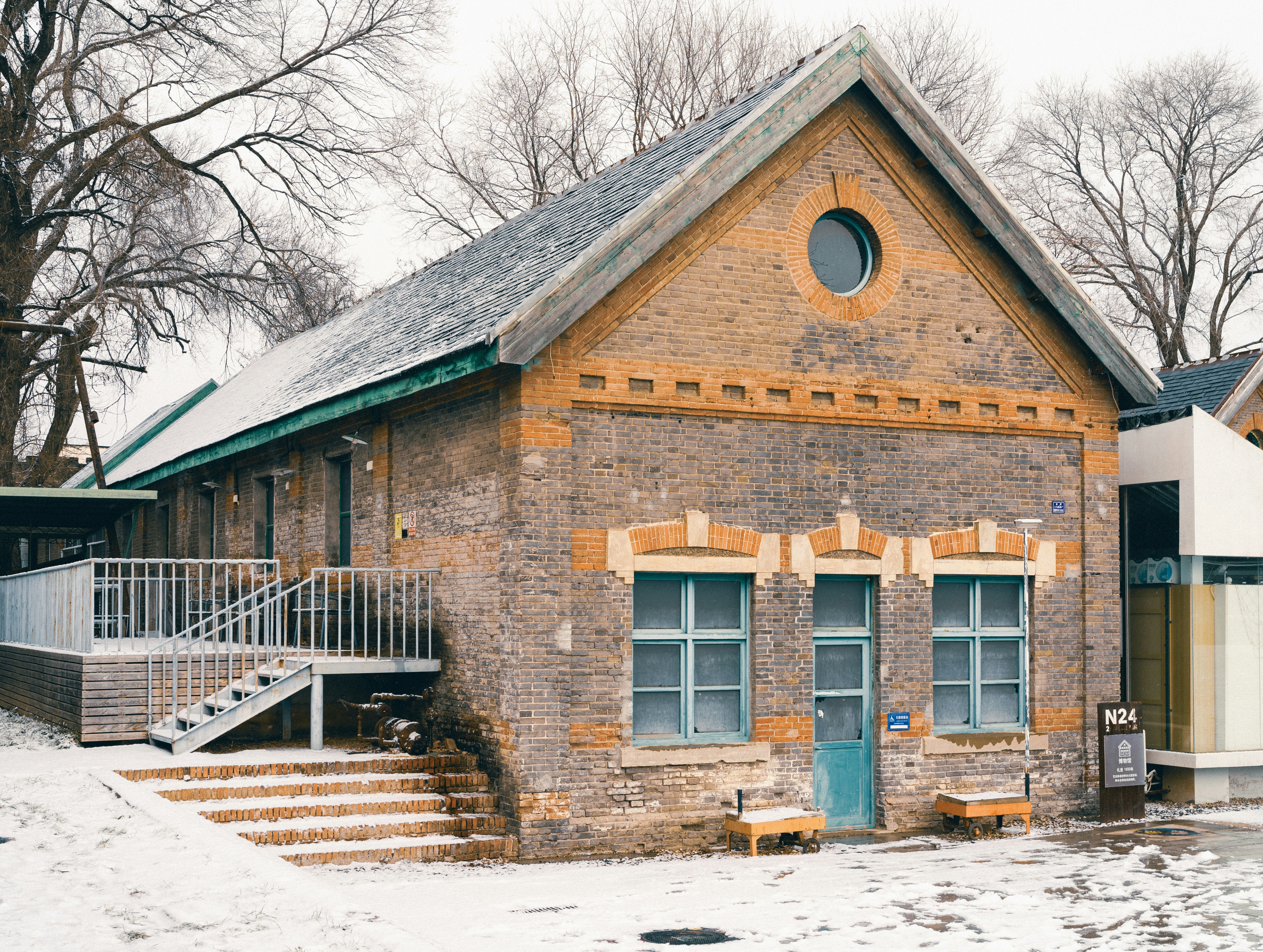 Snow-kissed Brick Station: A Quiet Winter Facade