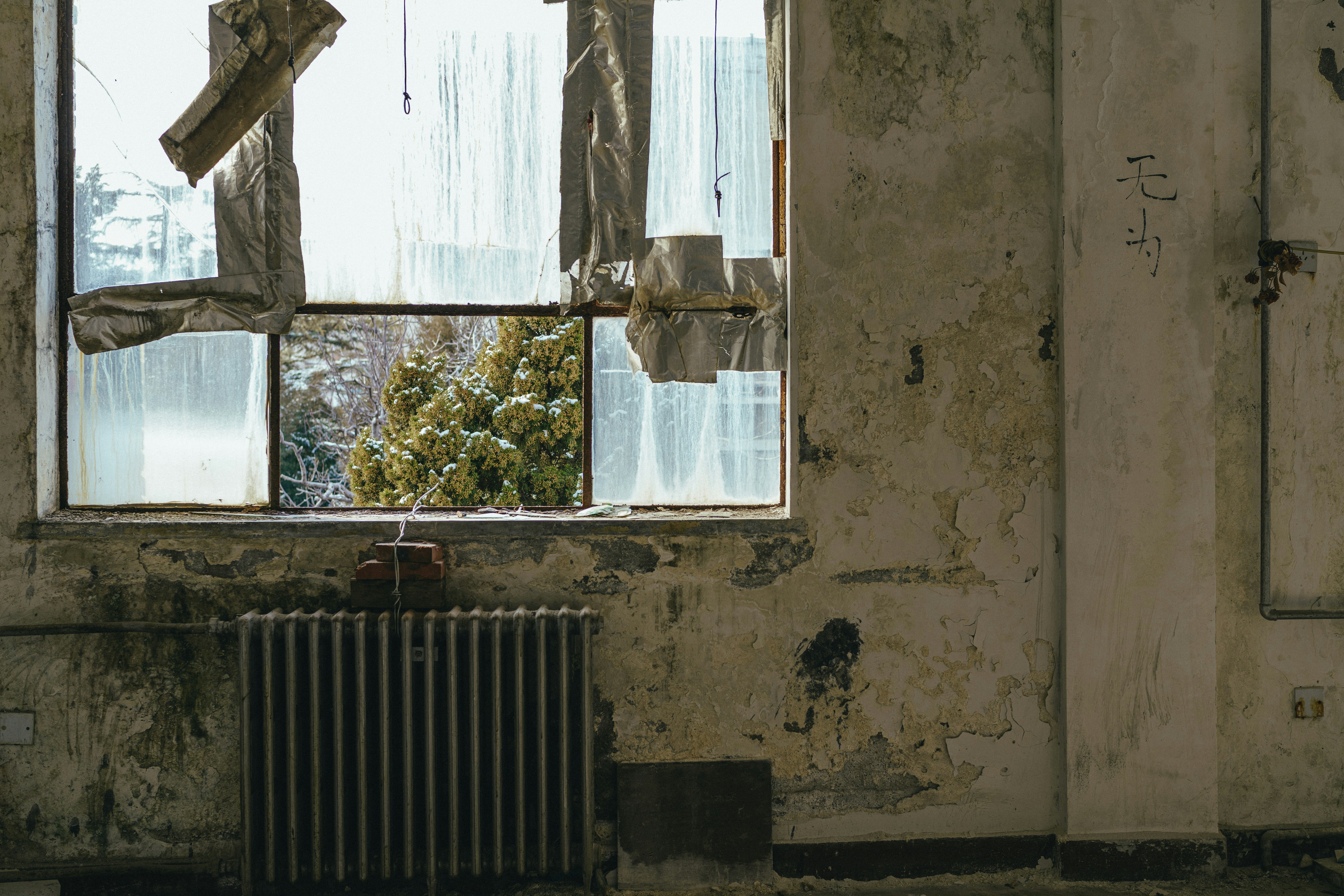 Breached Light: A Dilapidated Studio with a Fractured Window