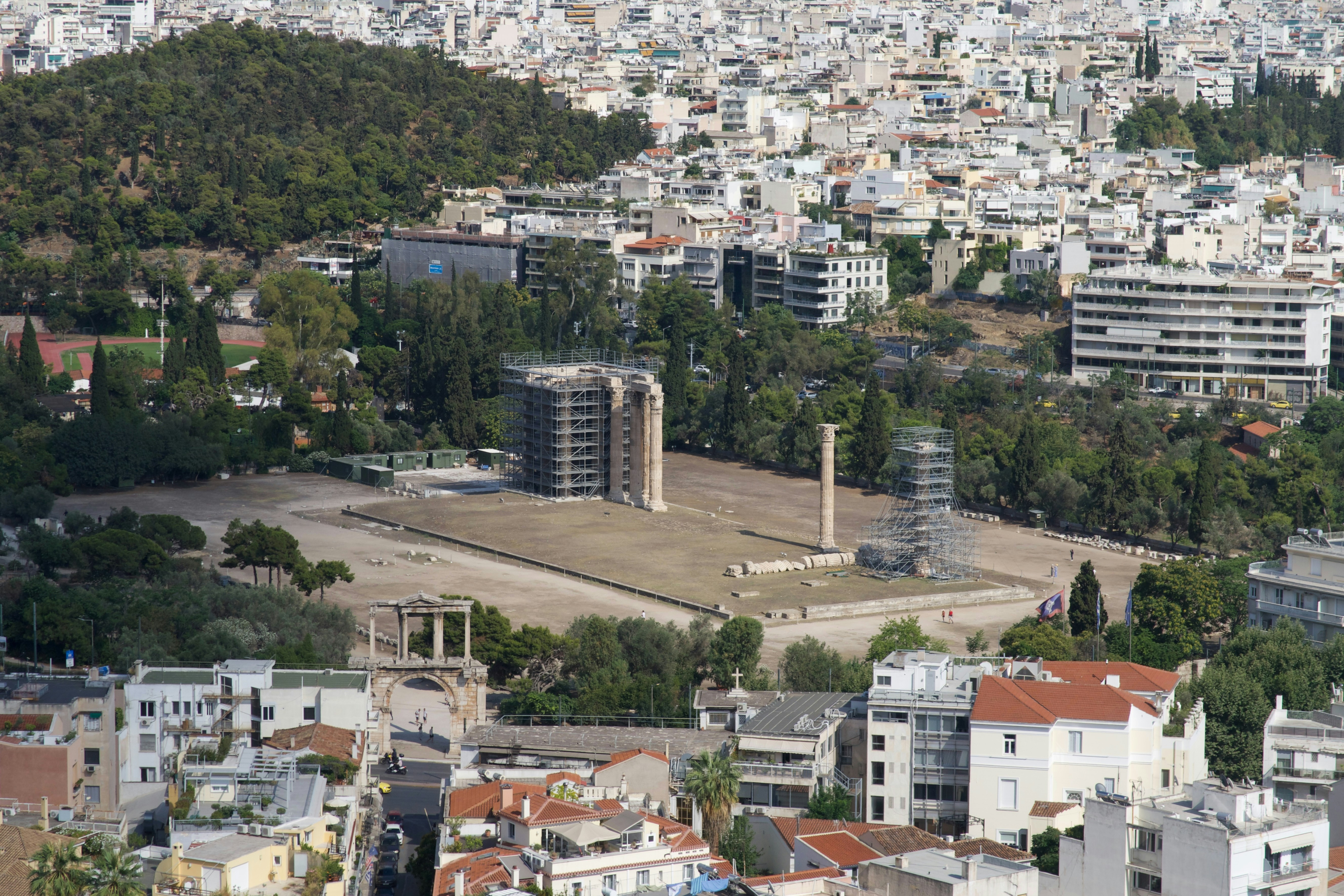 Urban plateau: terraced plaza and tower under a hillside skyline