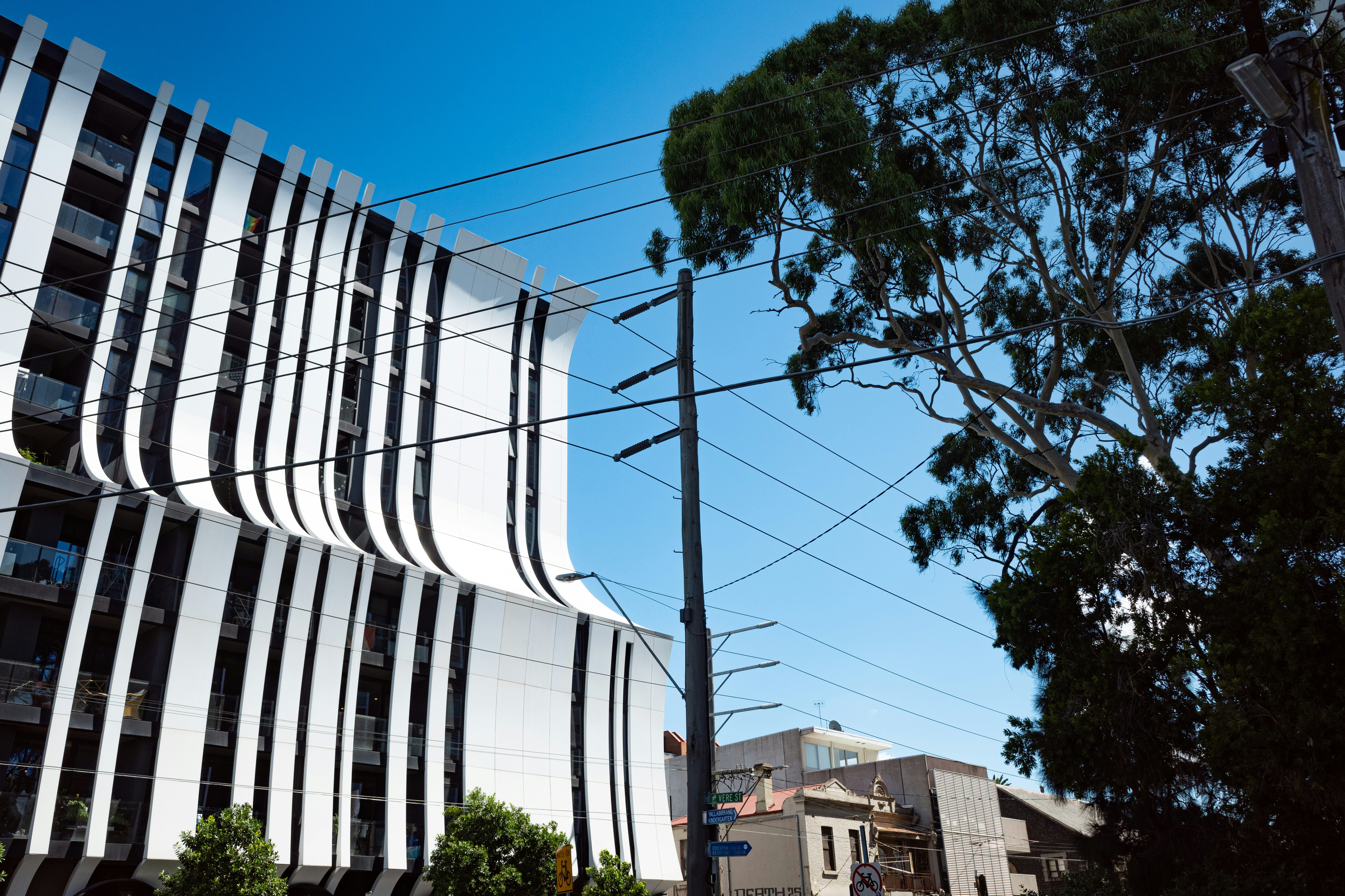 Curved Modern Facade Against a Bright Urban Sky