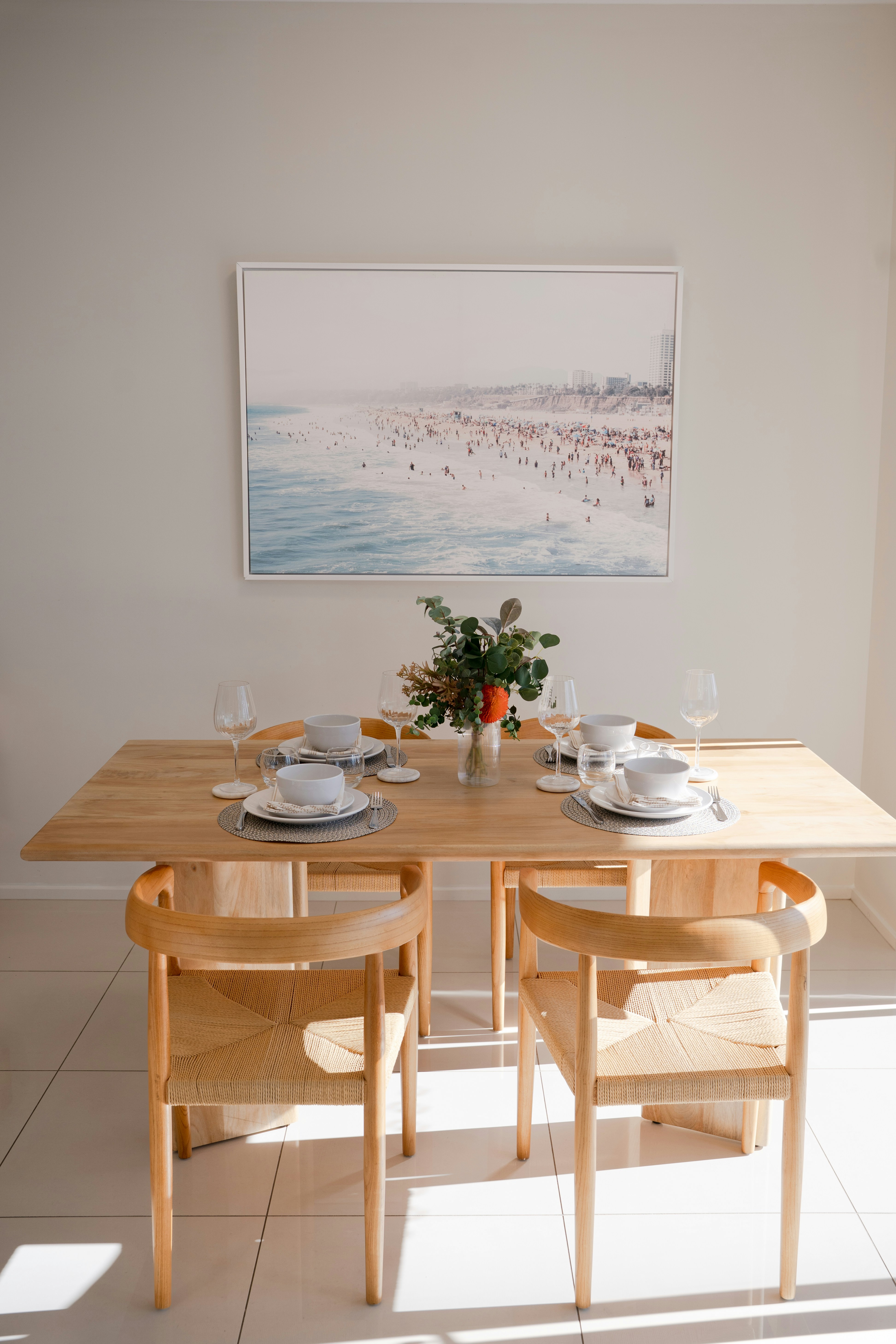 Sunlit dining for four: natural wood, clean lines, and a seaside-inspired centerpiece