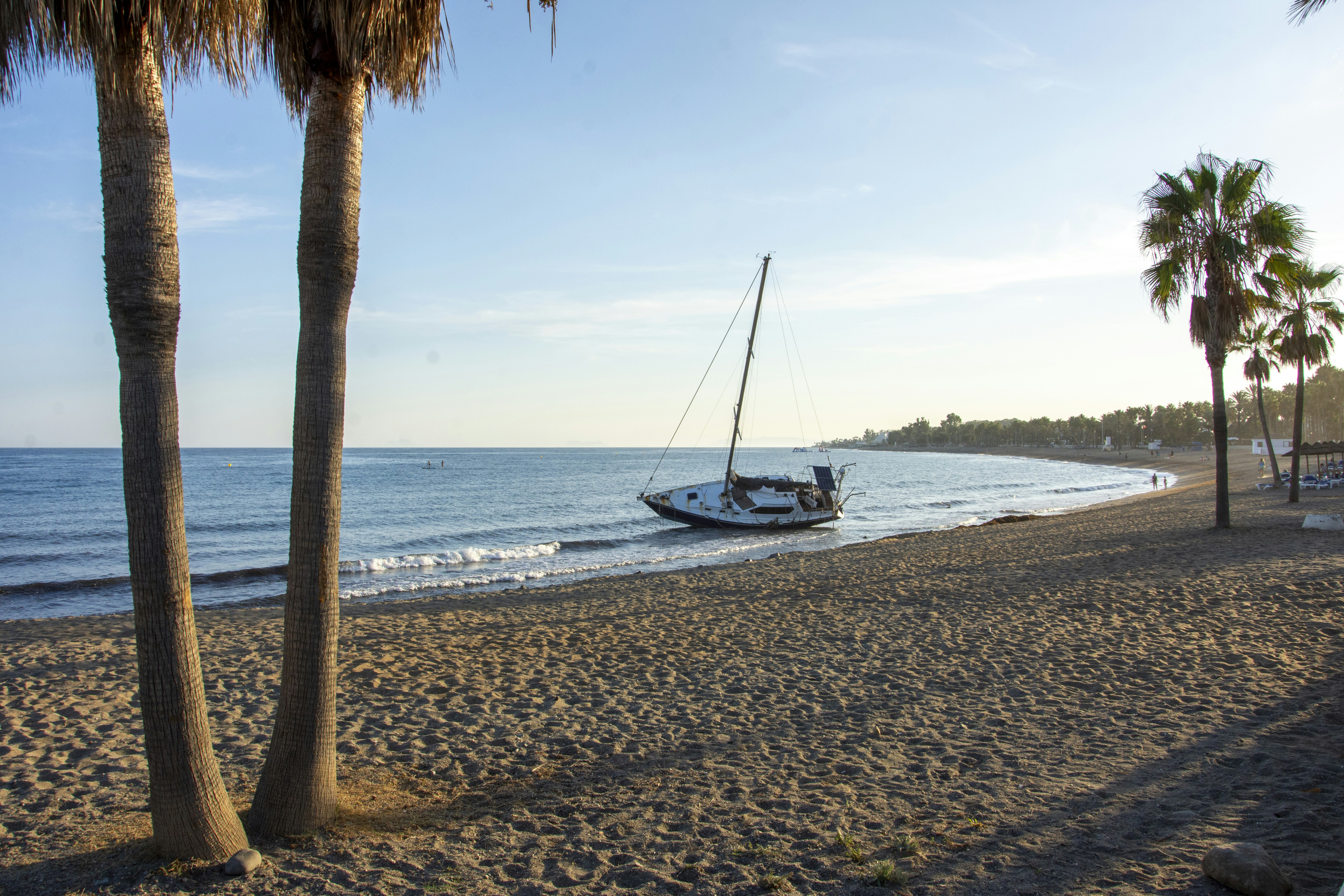 Sailboat Rest on the Quiet Beach at Golden Hour