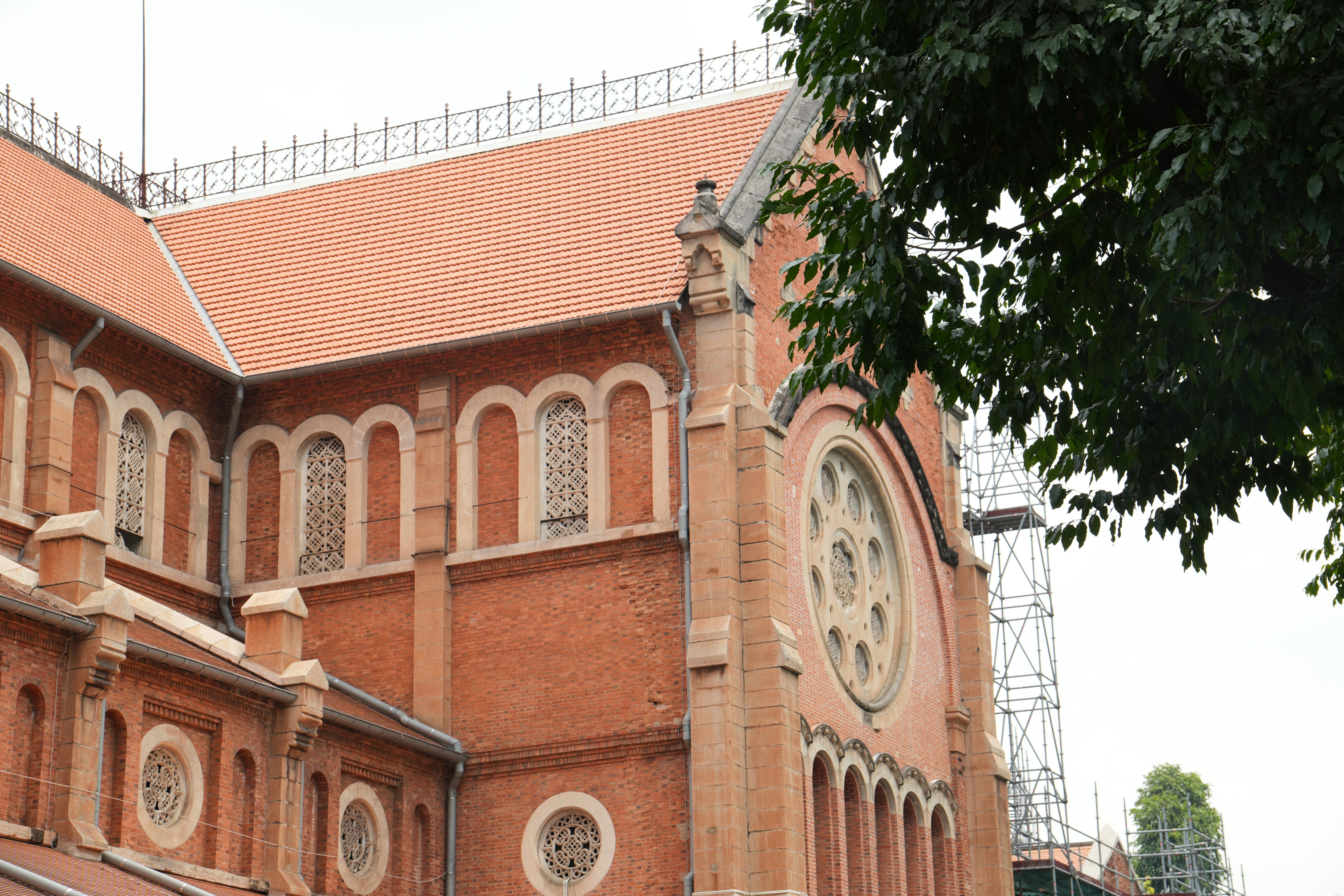 Brick Cathedral Facade with Circular Rose Window and Scrollwork