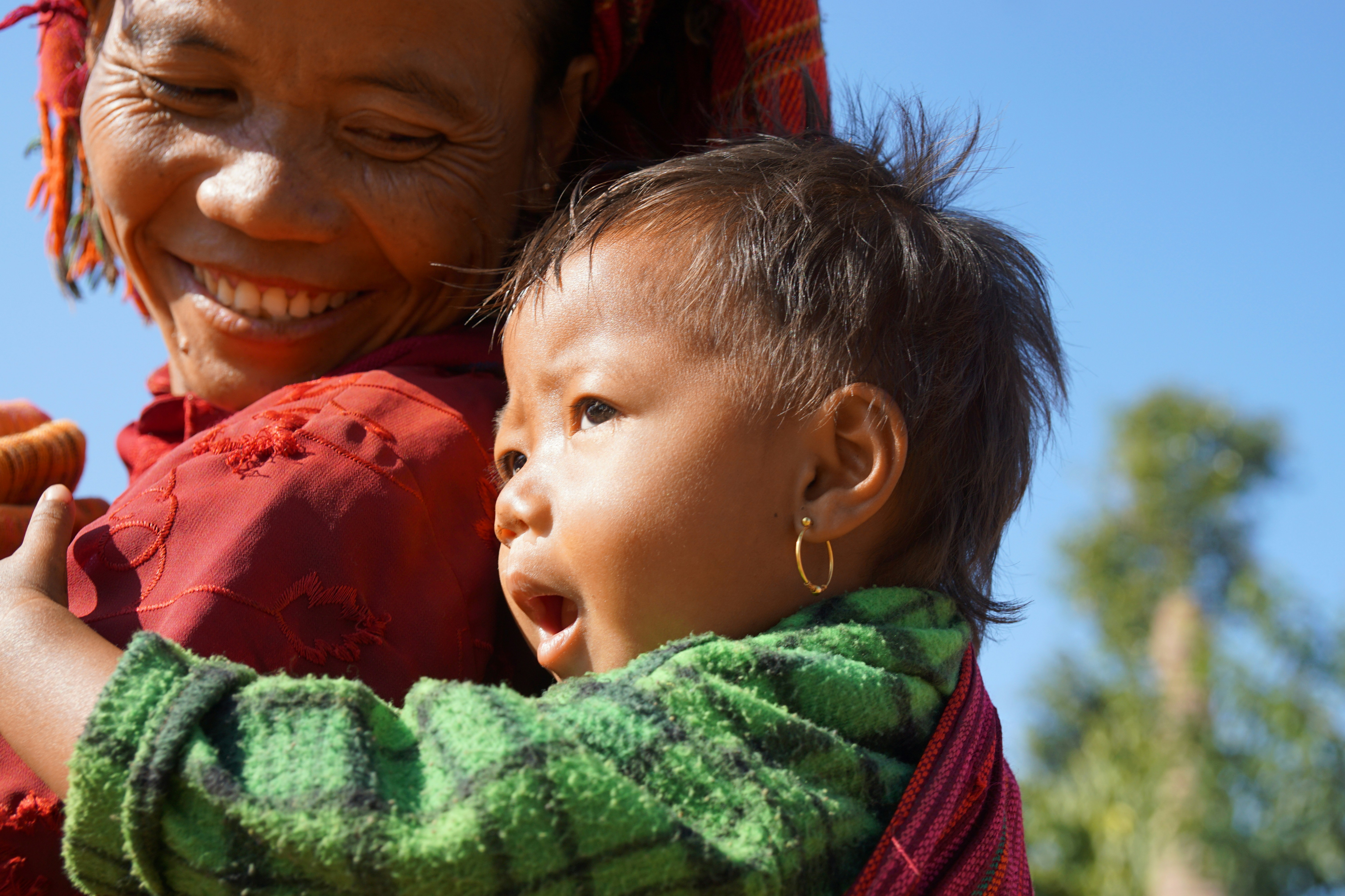 Mother's Warmth and Child's Wonder in Sunlit Outdoors