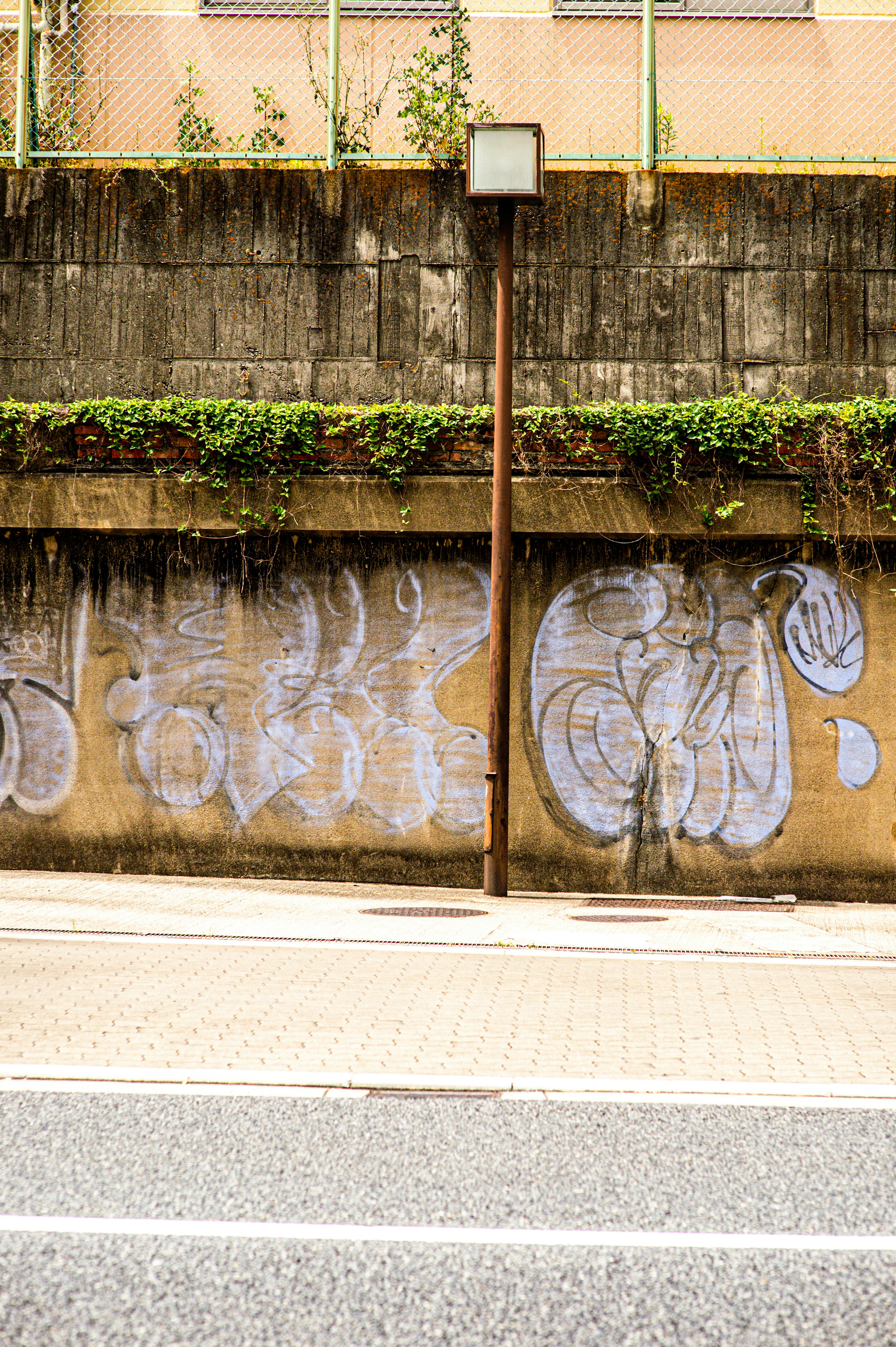 Midday Street Shadow and Graffiti Wall