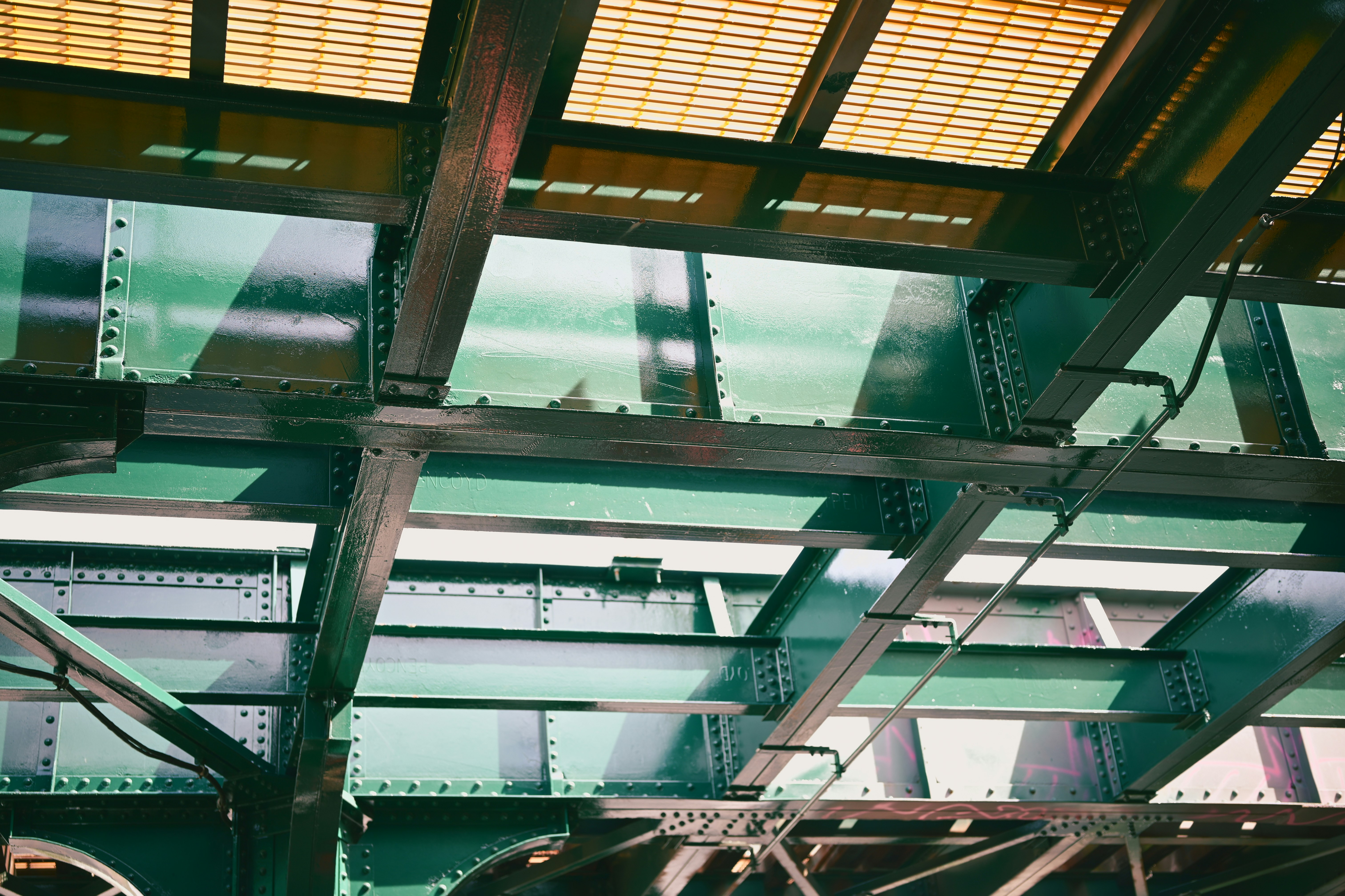 Geometric Glass Ceiling: Steel Beams and Colored Windows