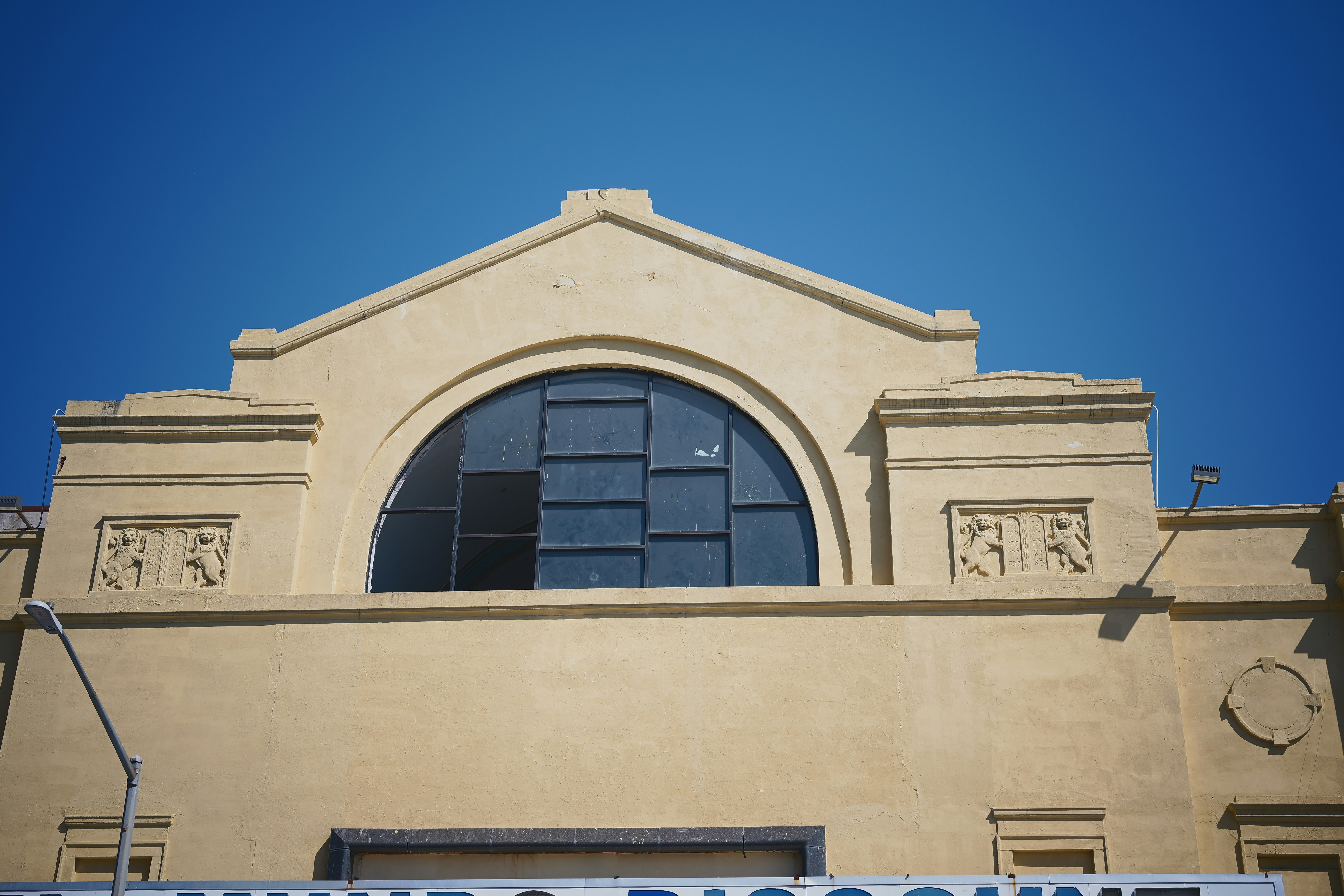 Arched Window Crown: A Sunlit Facade of a Classical Building