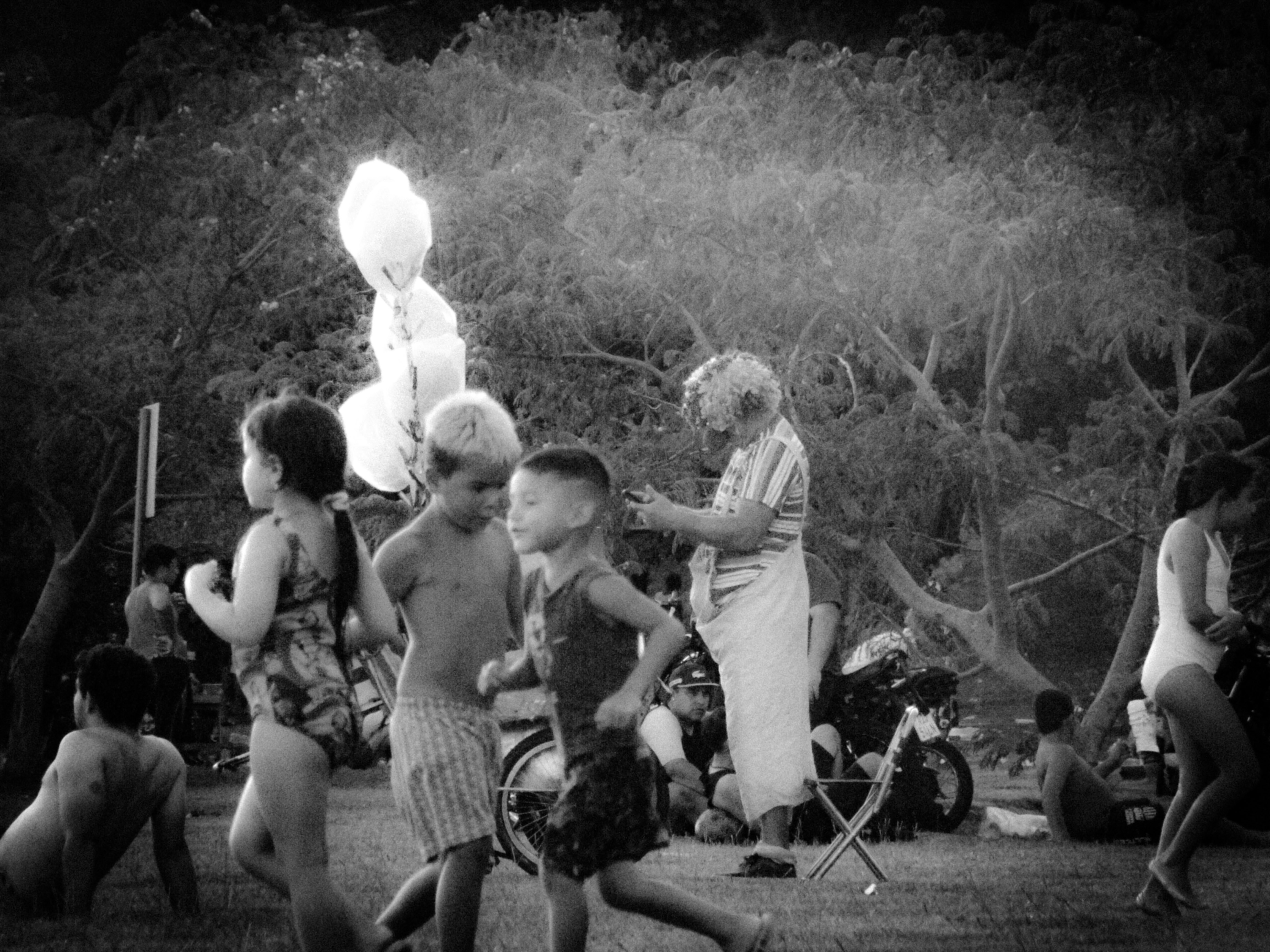 Playful Summer in grayscale: kids and beachside crowd