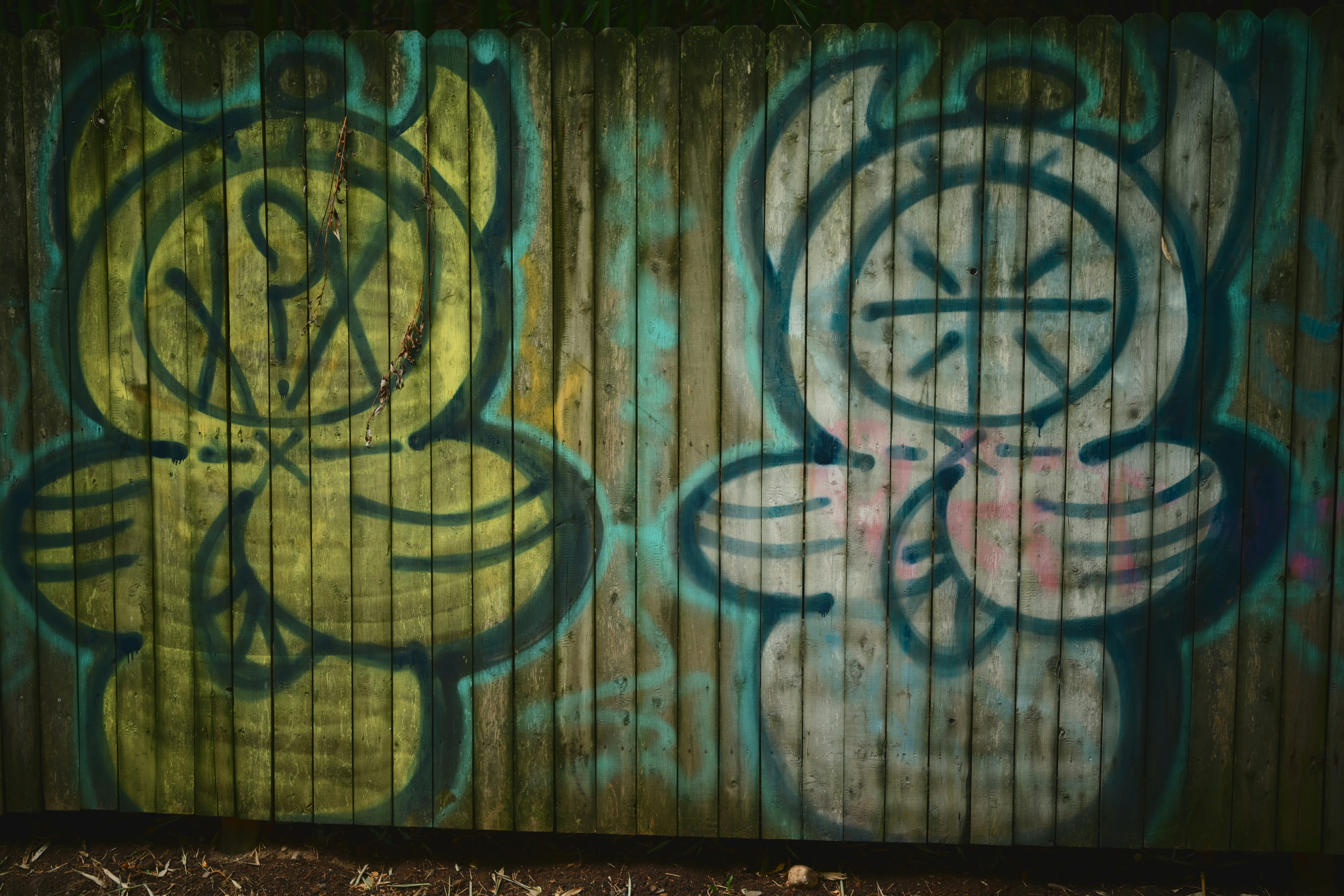 Two stylized graffiti figures painted on a wooden fence. photo – Free ...