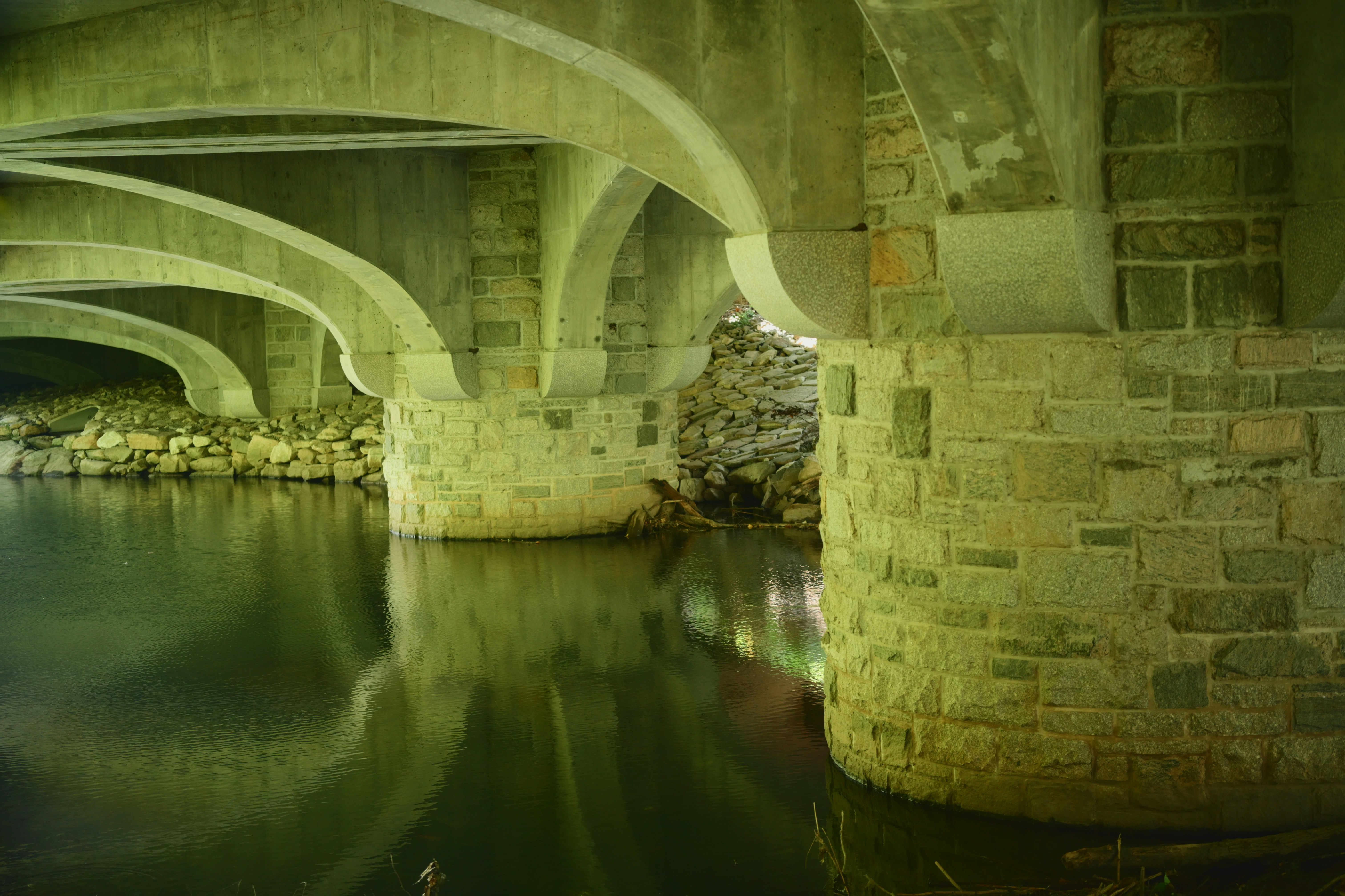 Green-tinted Underbridge Arches with Reflections