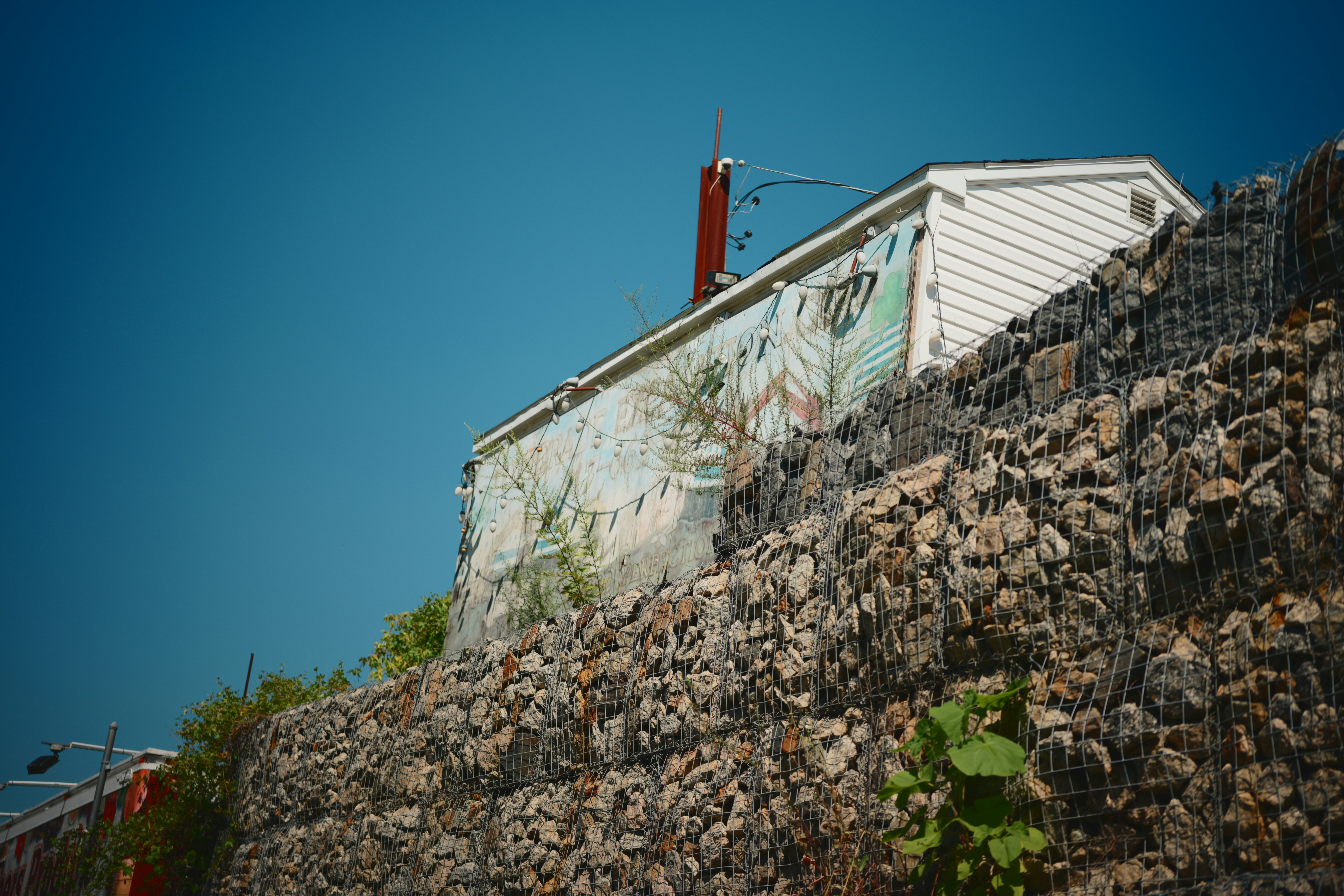 Rugged Terrace Overlook: A Walled Scene with a Graffitied Structure Above a Stone Face