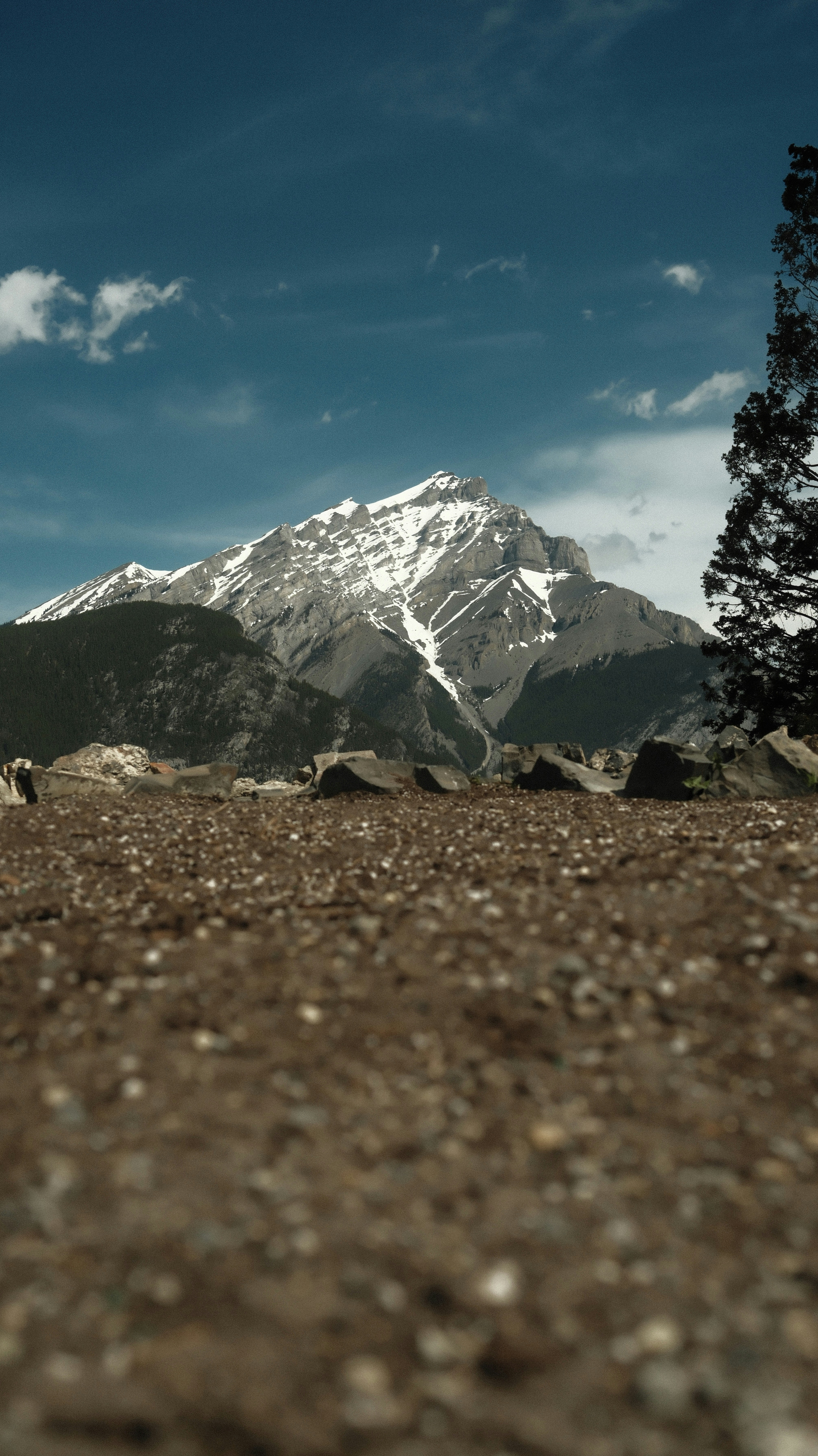 Snow-Crowned Peak Rising from a Pebble-Strewn Foreground