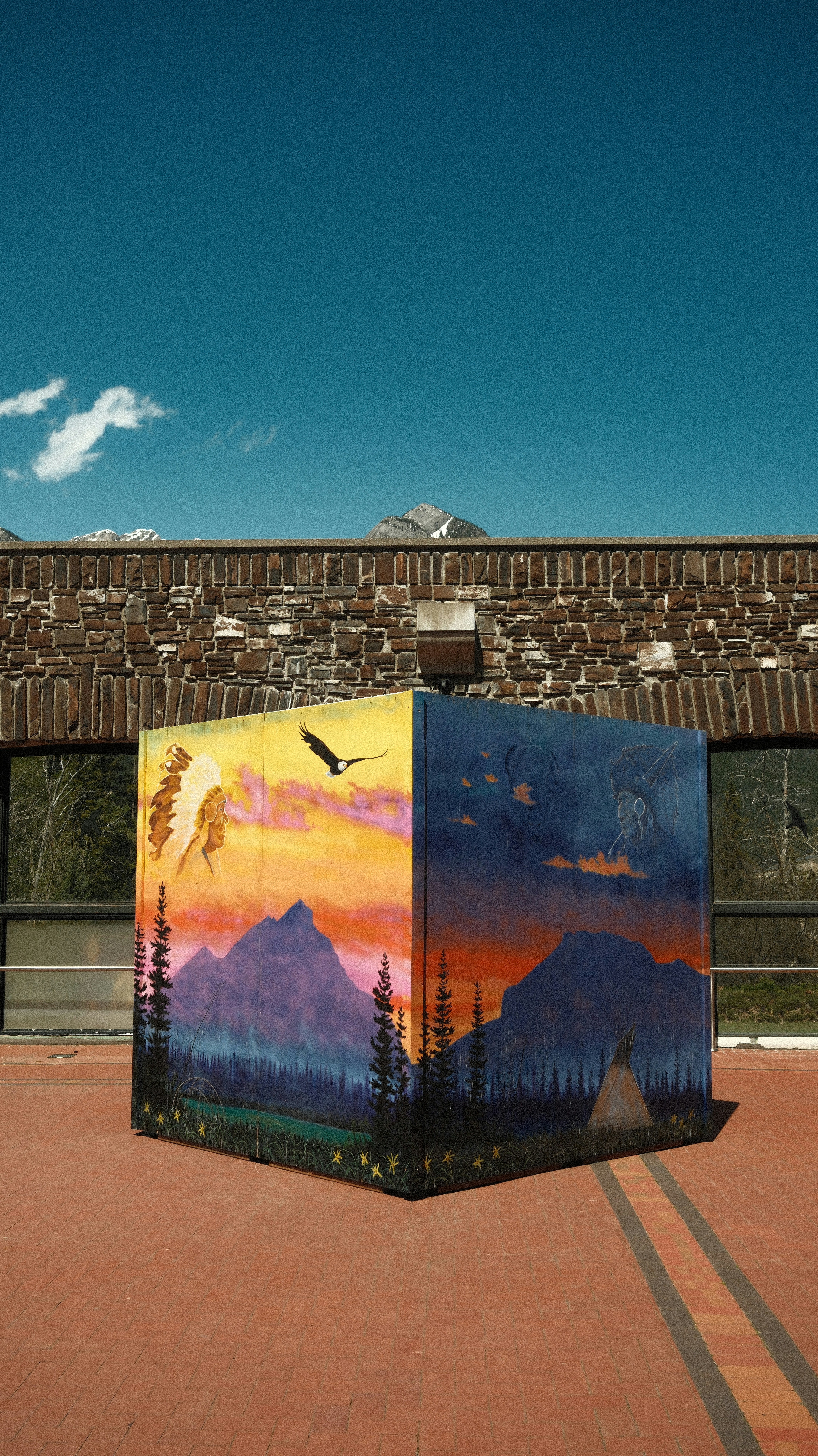 Sunset Over a Painted Summit: A Cubic Mural on Brick