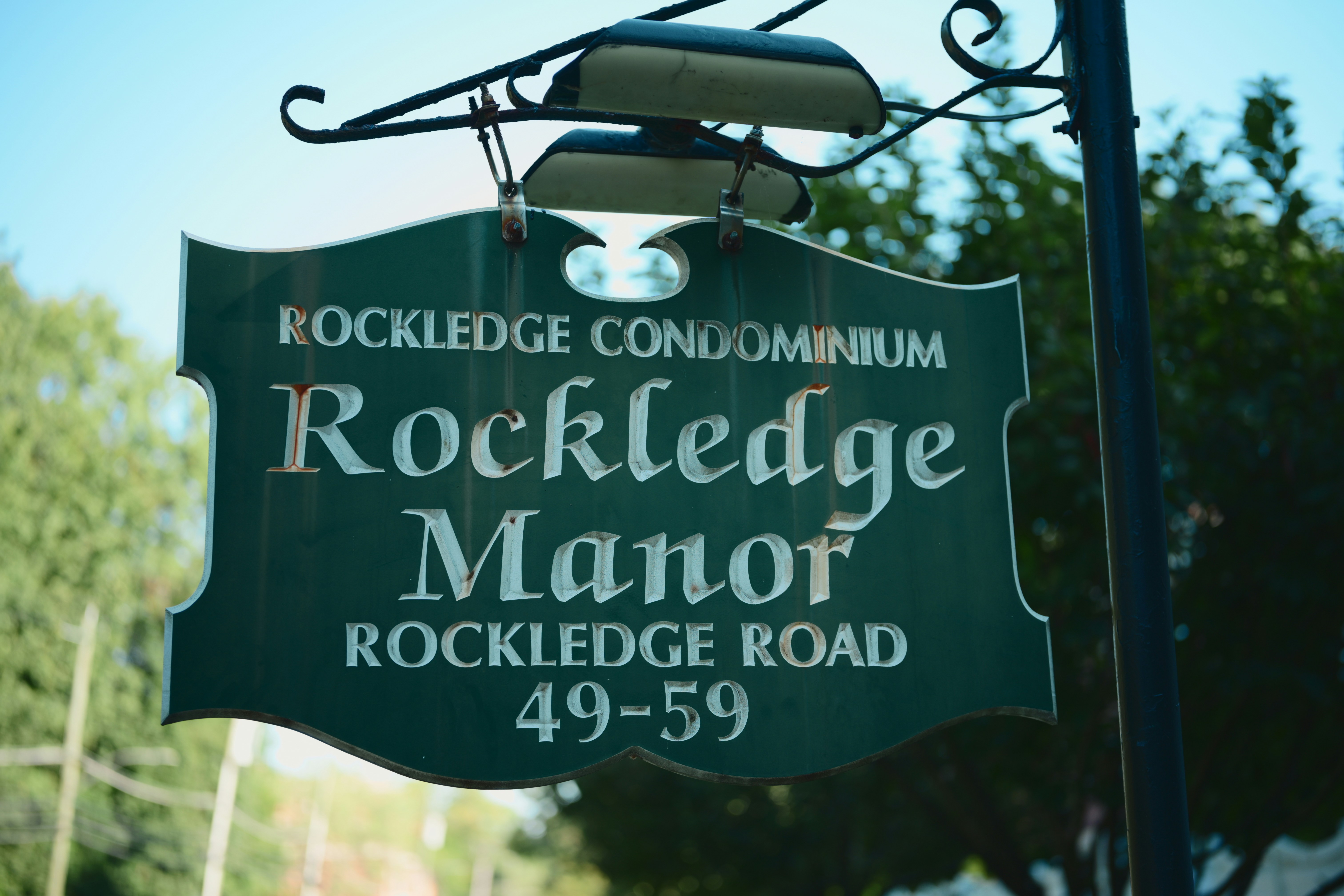 Rockledge Manor: A Green Sign Amid Suburban Dusk